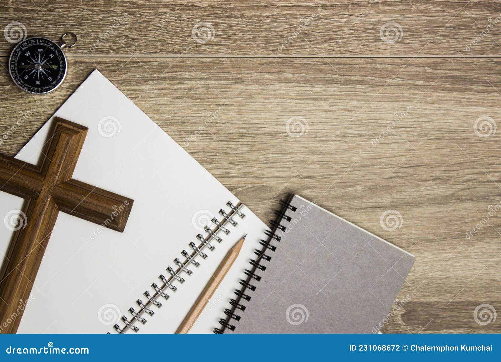 A Cross with White Notebook and Compass Over the Wooden Table. Stock ...