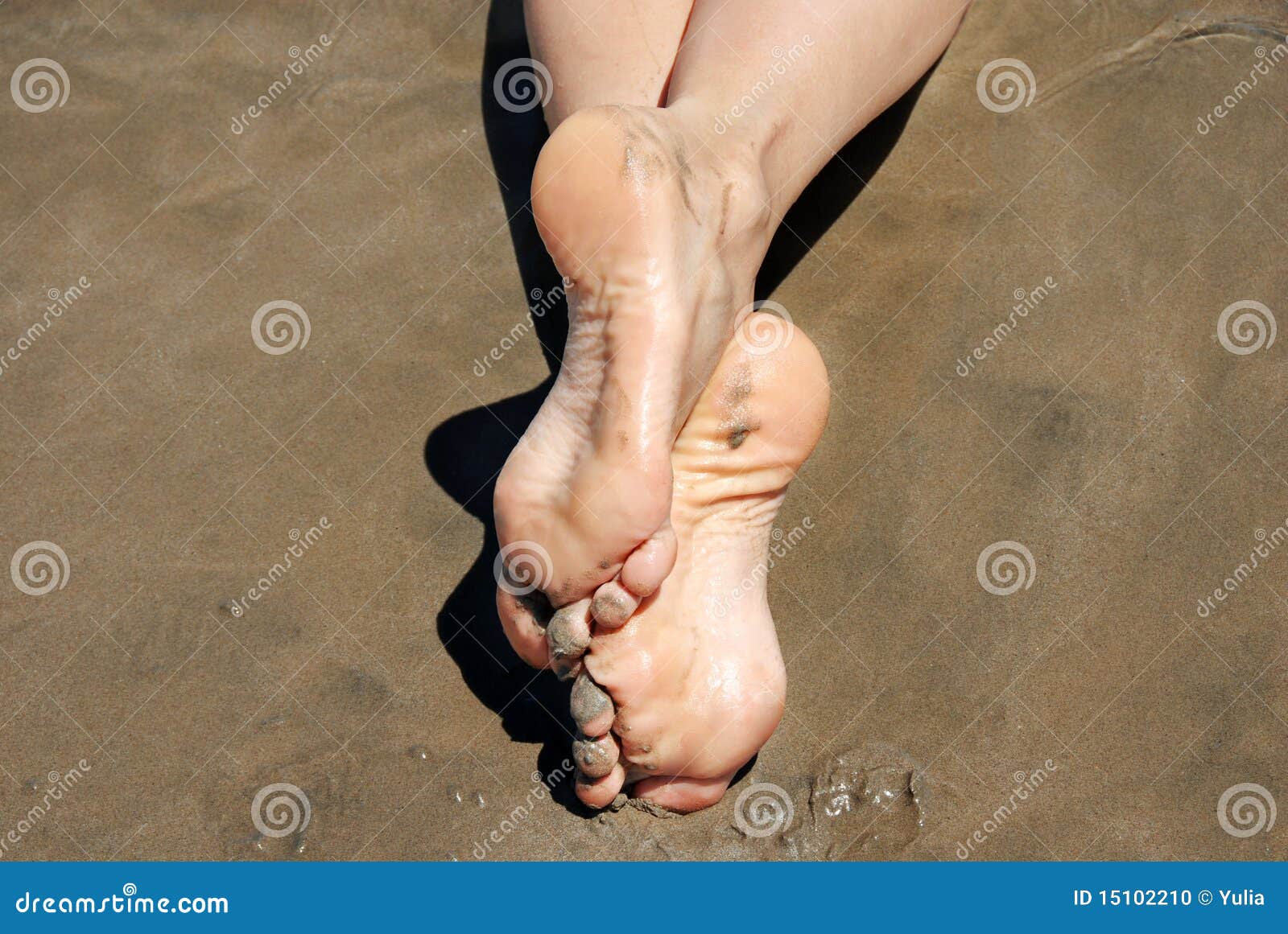 Crossed feet in sand stock photo. Image of barefooted - 15102210