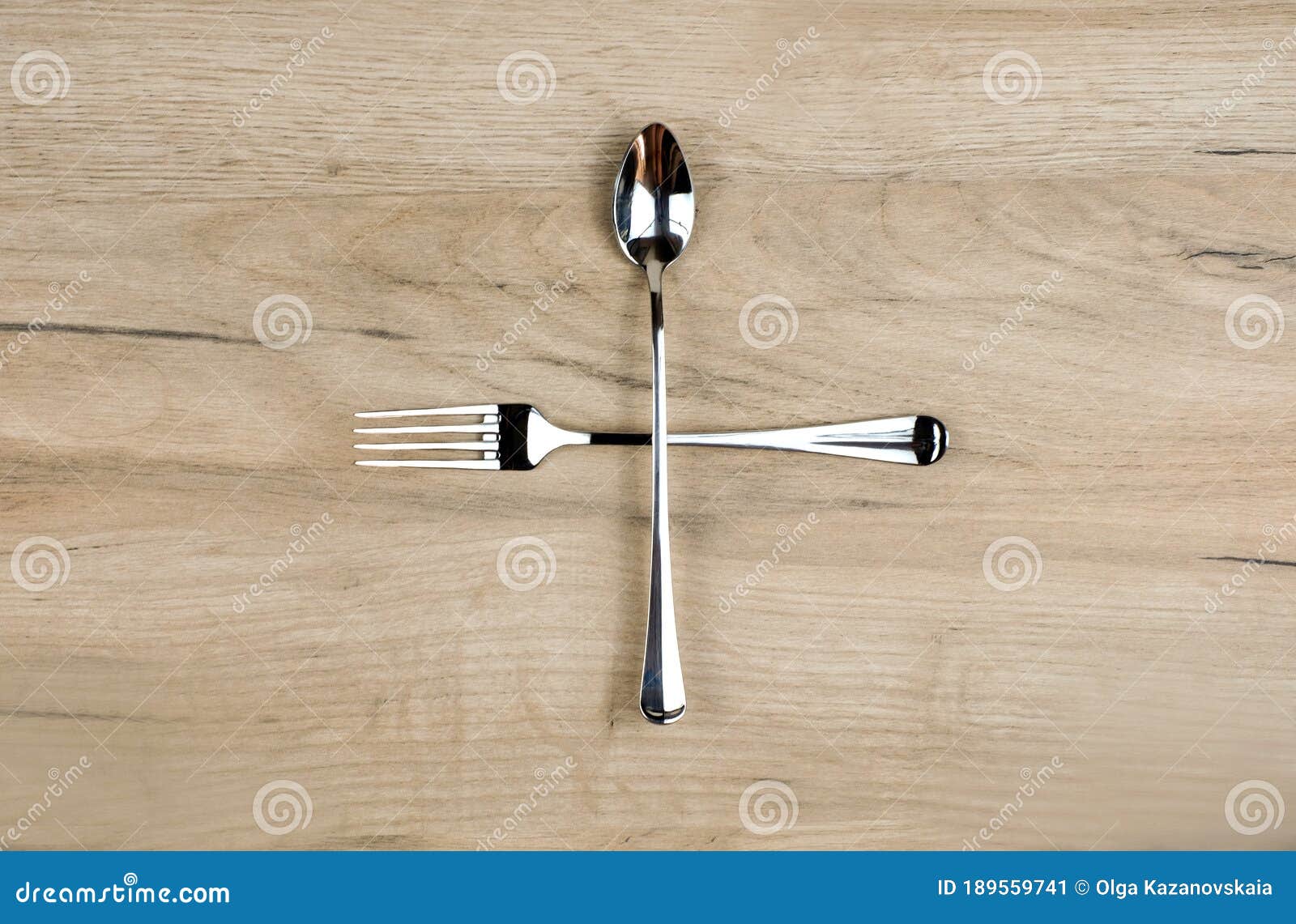 Crossed Fork and Spoon on Wooden Table Stock Image - Image of ...