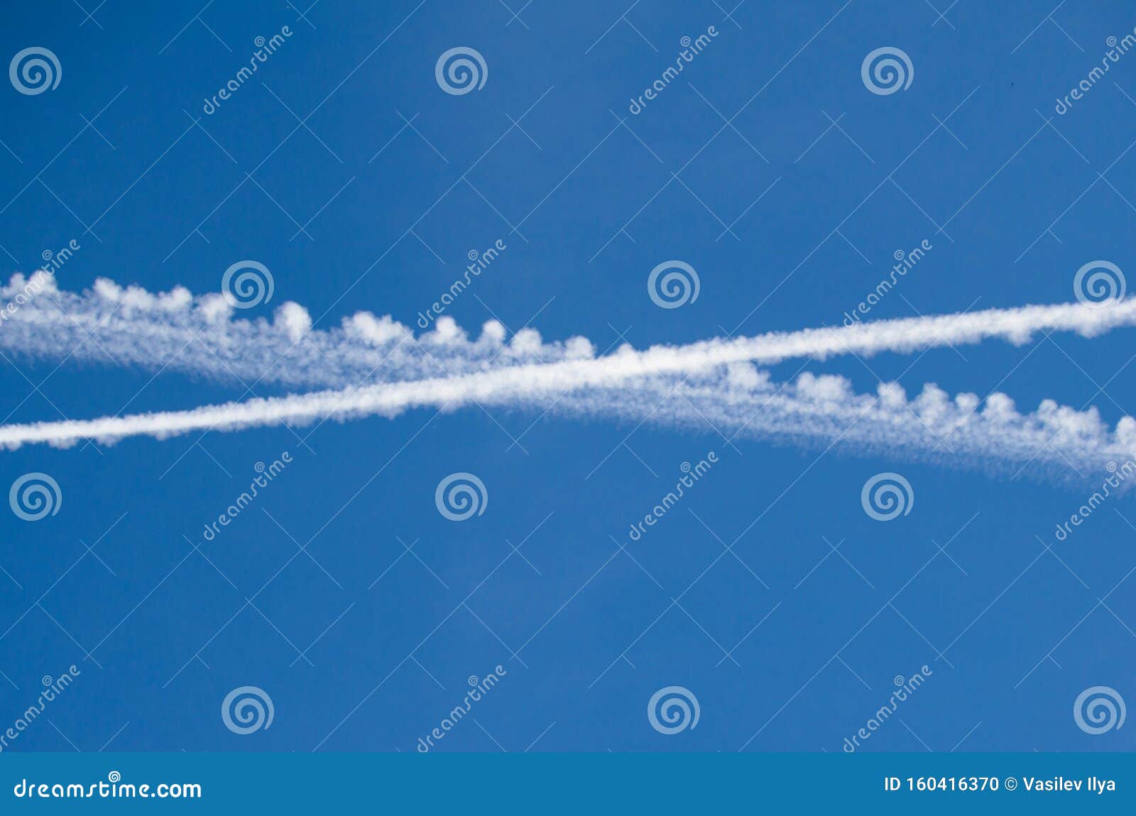Crossed Traces of Planes in the Clear Blue Sky Stock Photo - Image of ...