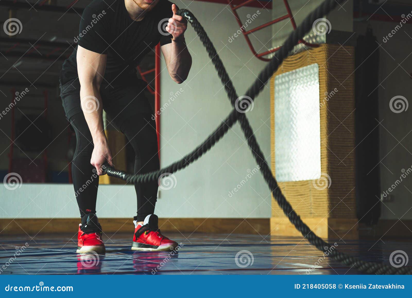 Crossfit with Ropes. the Athlete is Training in the Gym. Stock Photo ...