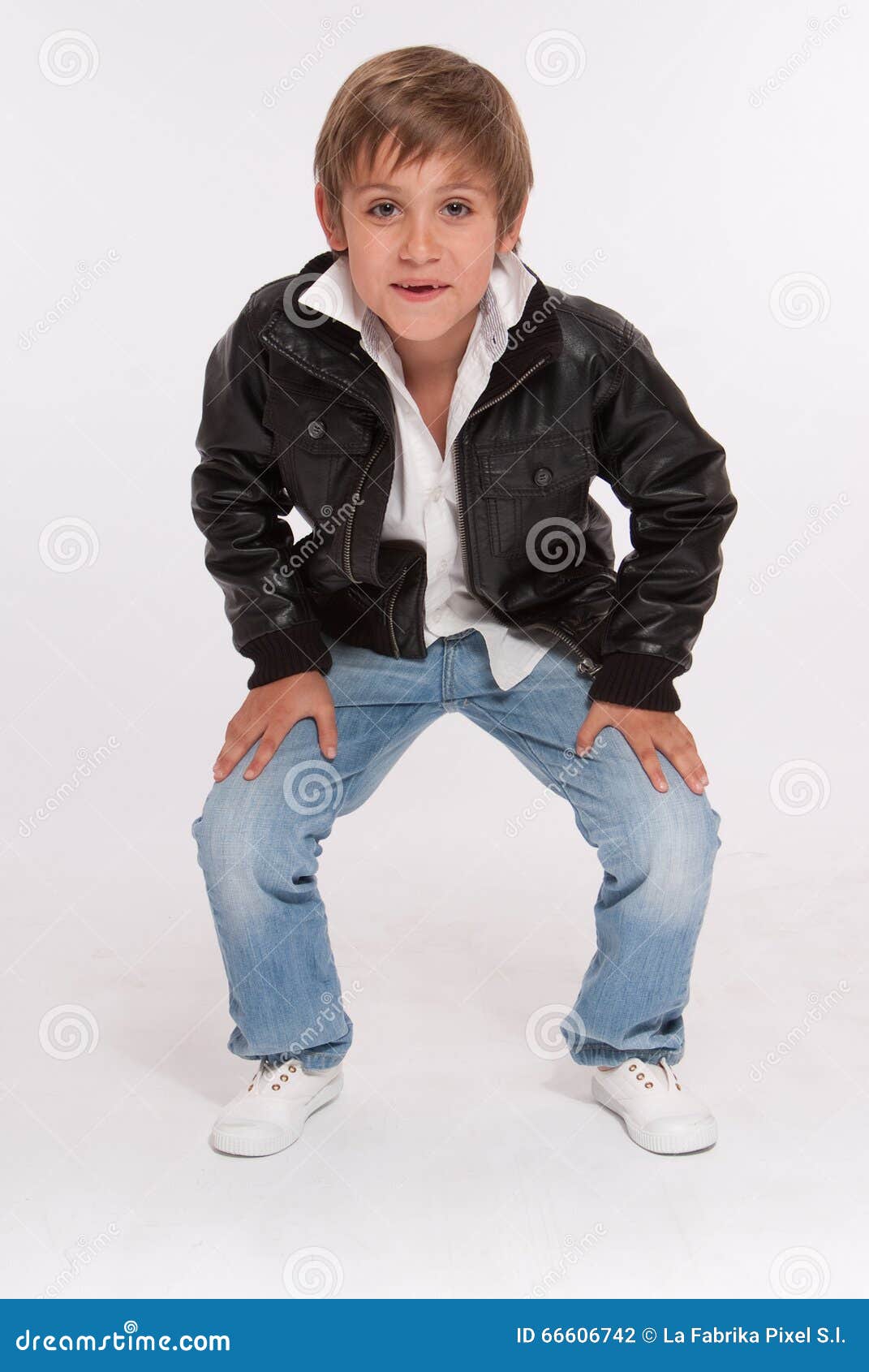 Crouching boy stock photo. Image of sneakers, jeans, cute - 66606742