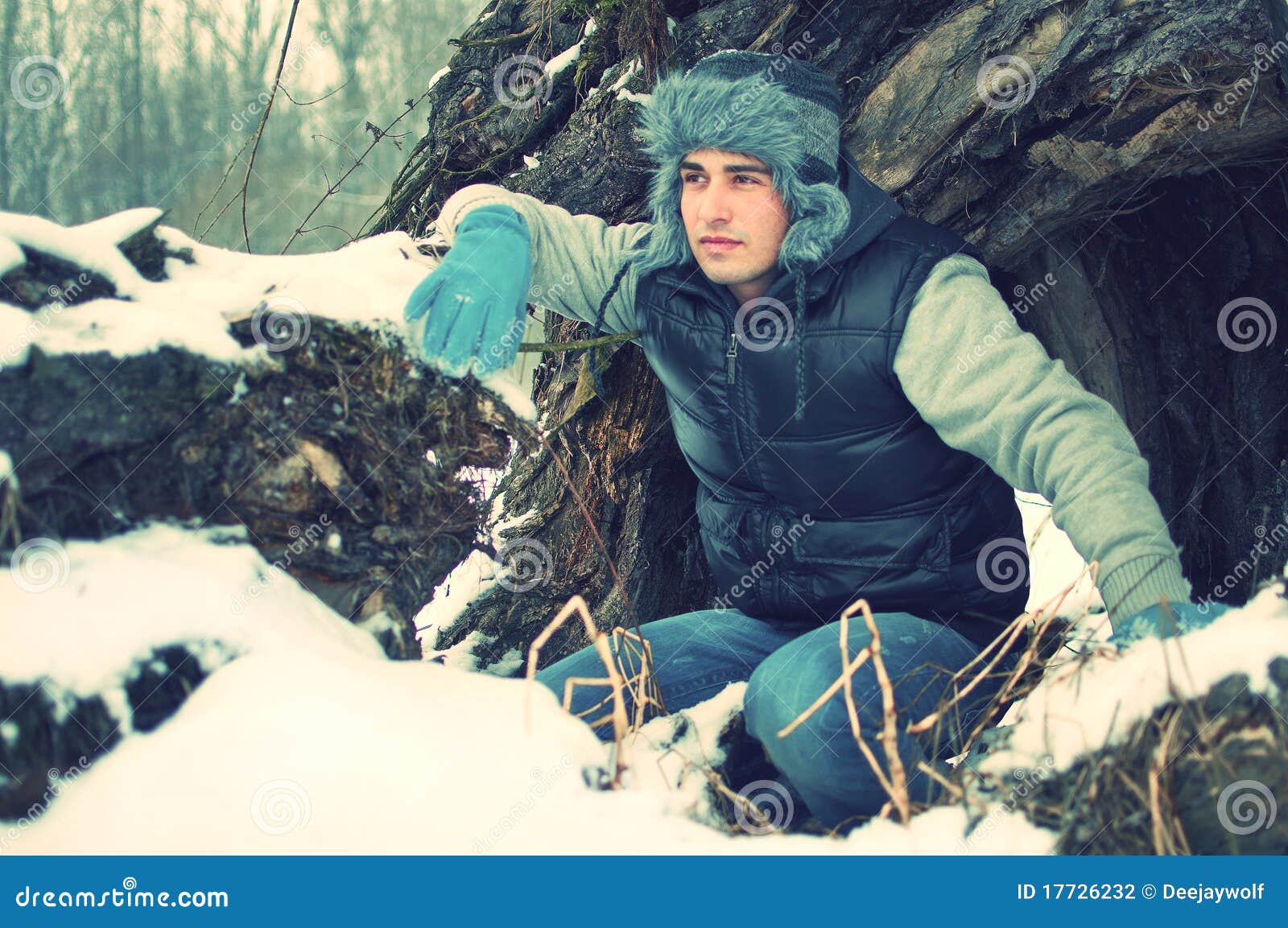 Crouching Handsome Young Man in Winter Stock Photo - Image of cold ...