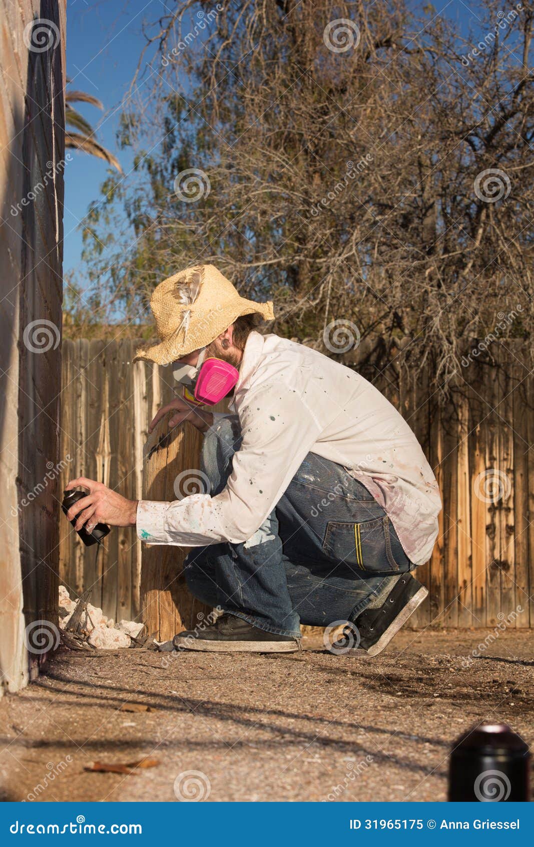 Crouching Man Spray Painting Stock Image - Image of holding, outdoors ...