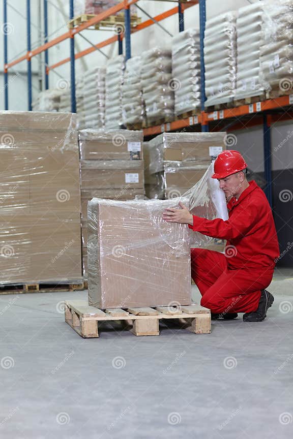 Crouching Worker Wrapping Box on Pallet Stock Photo - Image of label ...