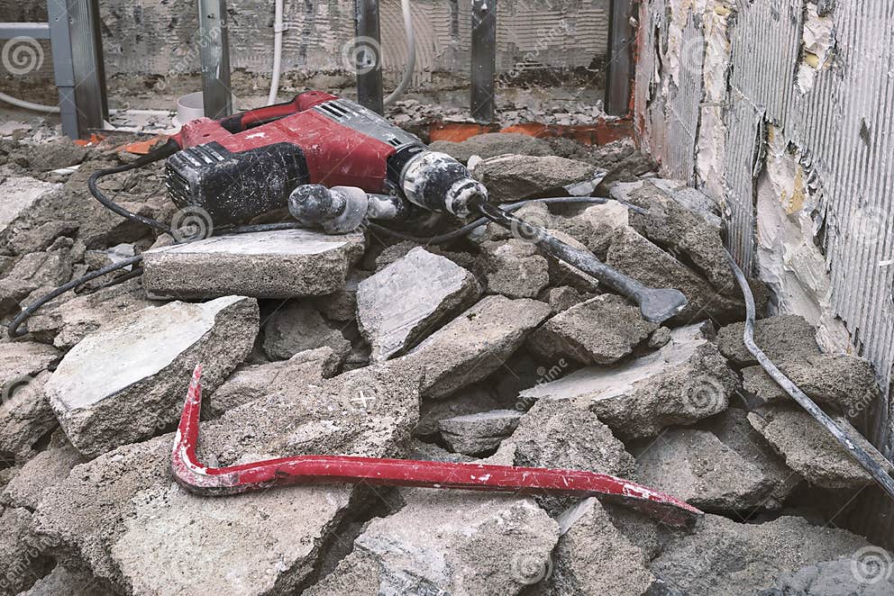 The Crowbar and Jackhammer Lies on Large Pieces of Broken Cement Walls ...