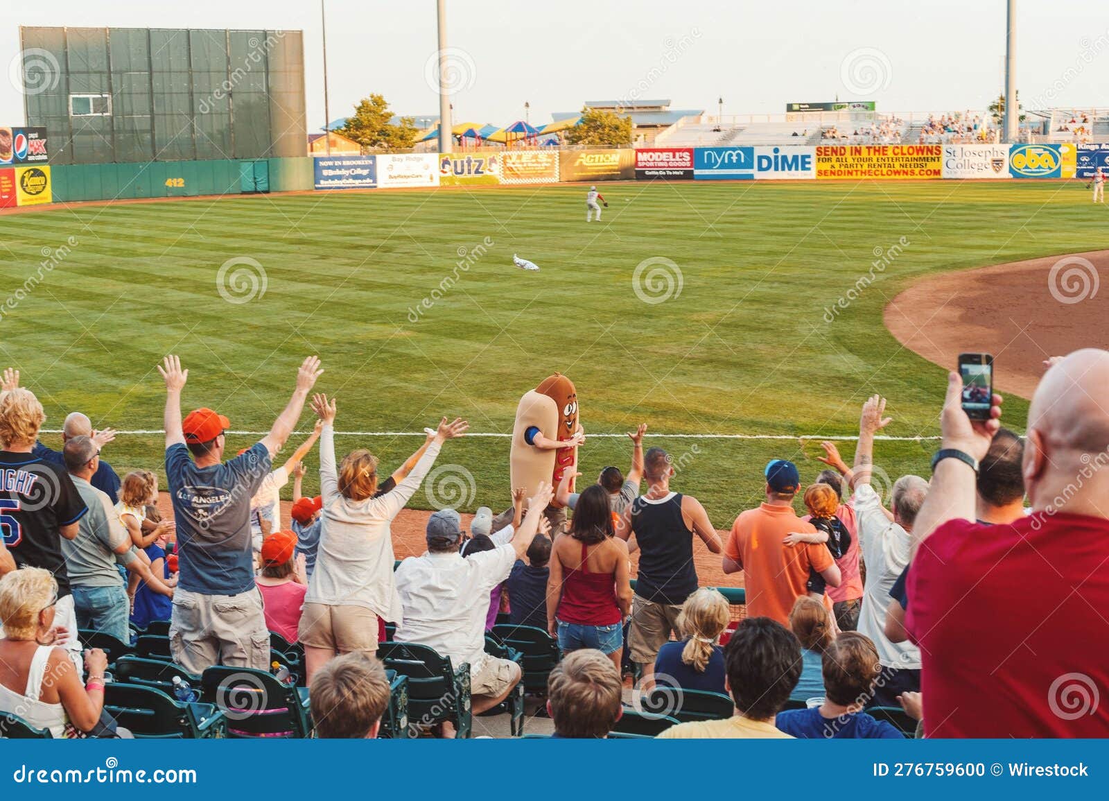 A Crowd in Chairs Watching a Game with Spectators Holding Up Their ...