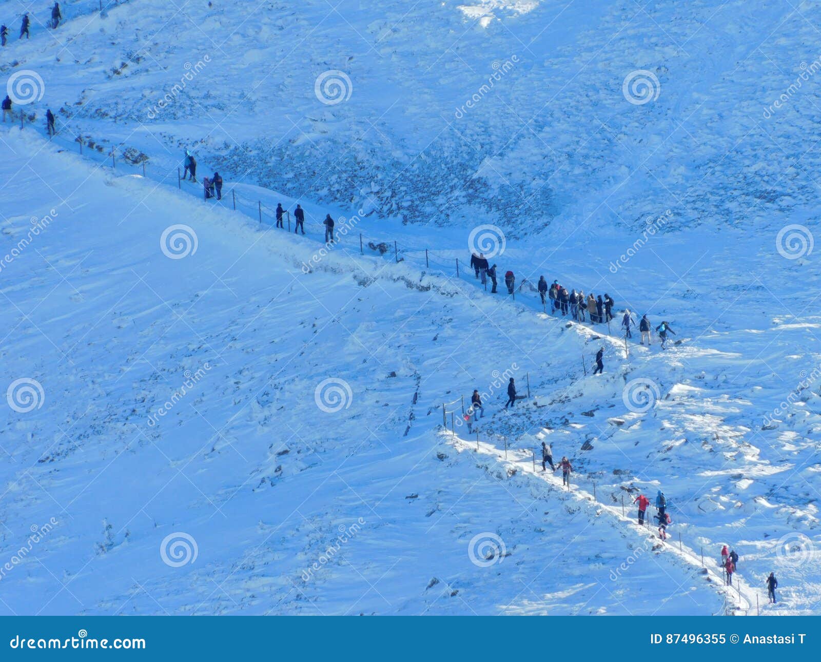 Crowded path in mountains stock image. Image of snow - 87496355