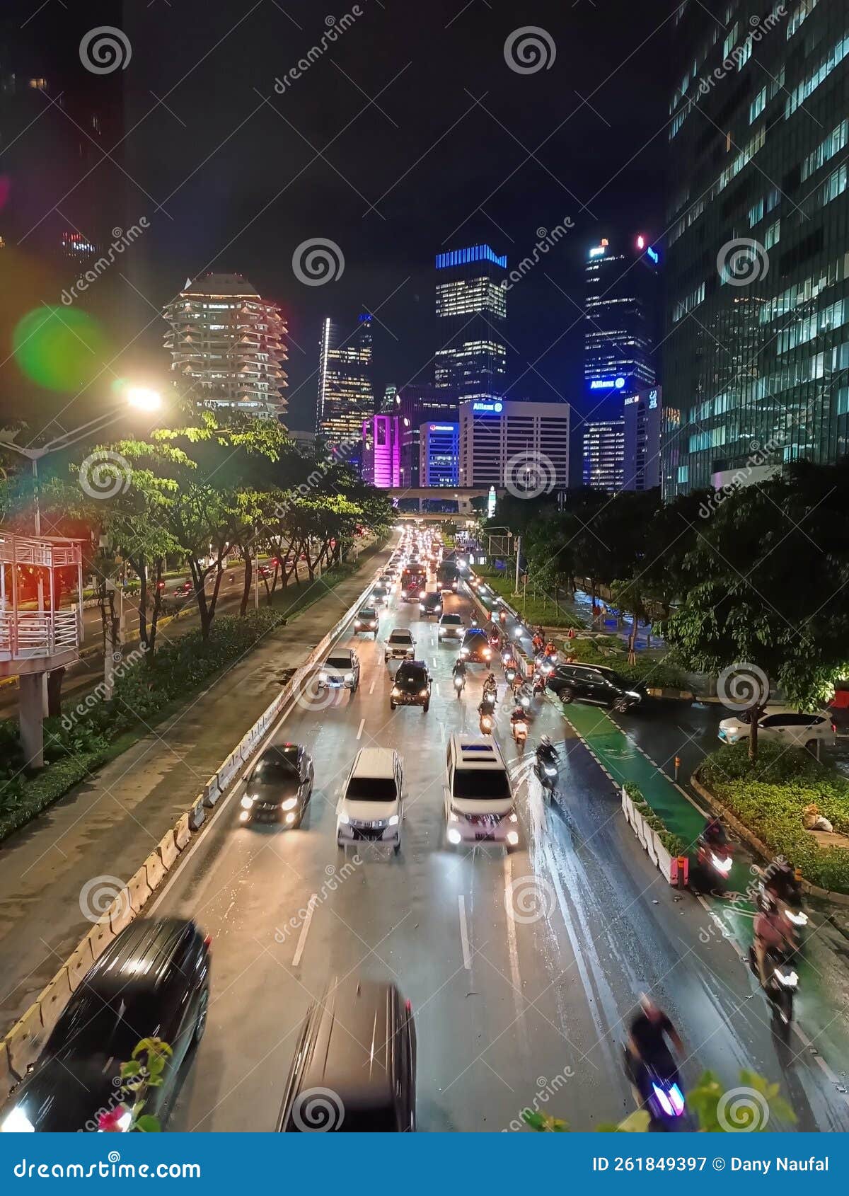Crowded Traffic in the City Center at Night with with a Building ...