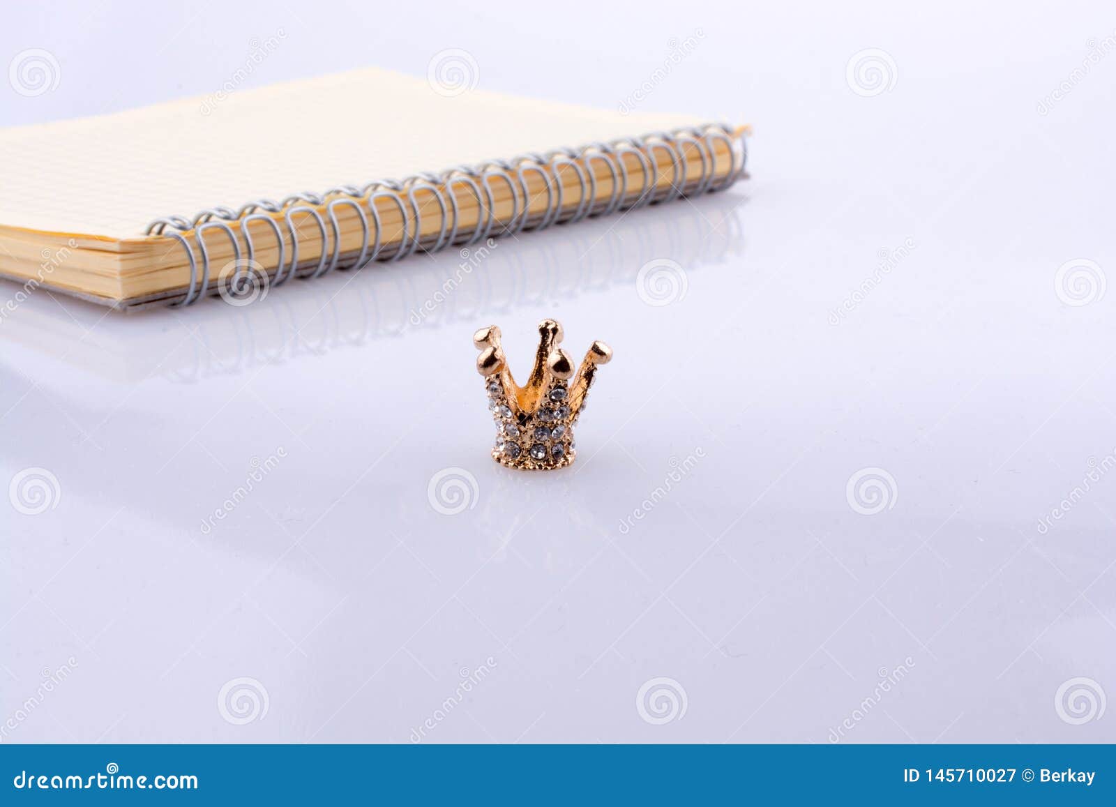 Crown with a notebook stock image. Image of sheet, design - 145710027