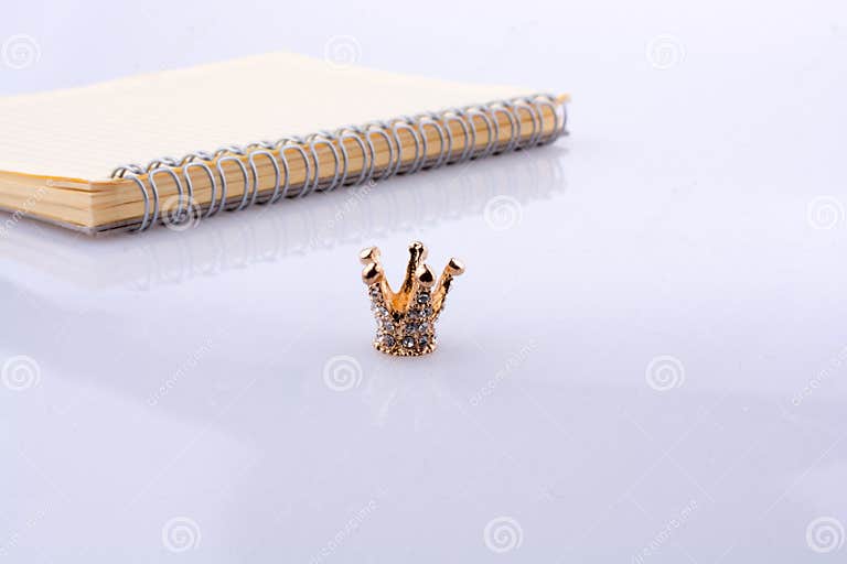Crown with a notebook stock image. Image of sheet, design - 145710027