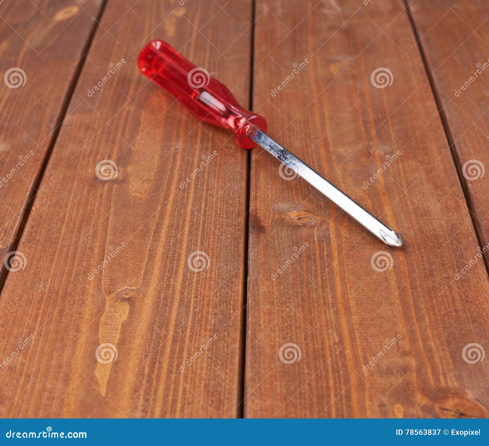 Cruciform Screwdriver with the Red Handle on Wooden Surface Stock Image ...
