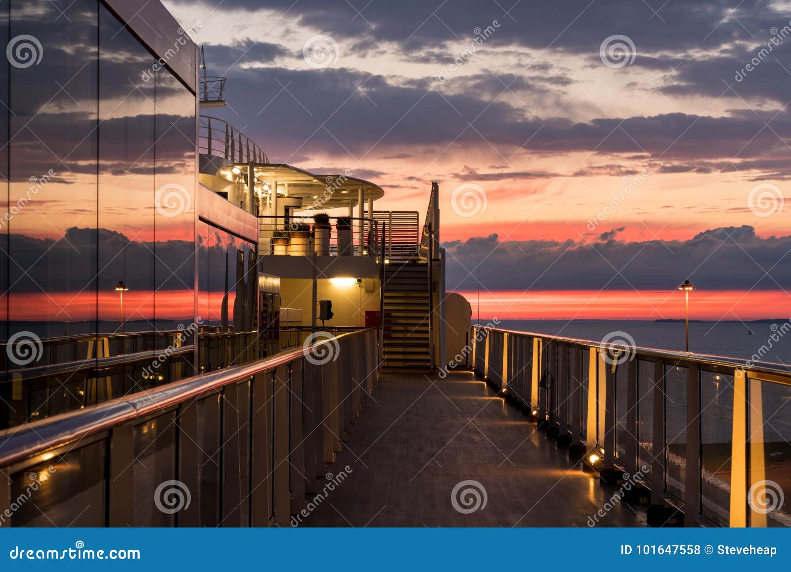 Cruise ship deck at sunset stock photo. Image of railing - 101647558