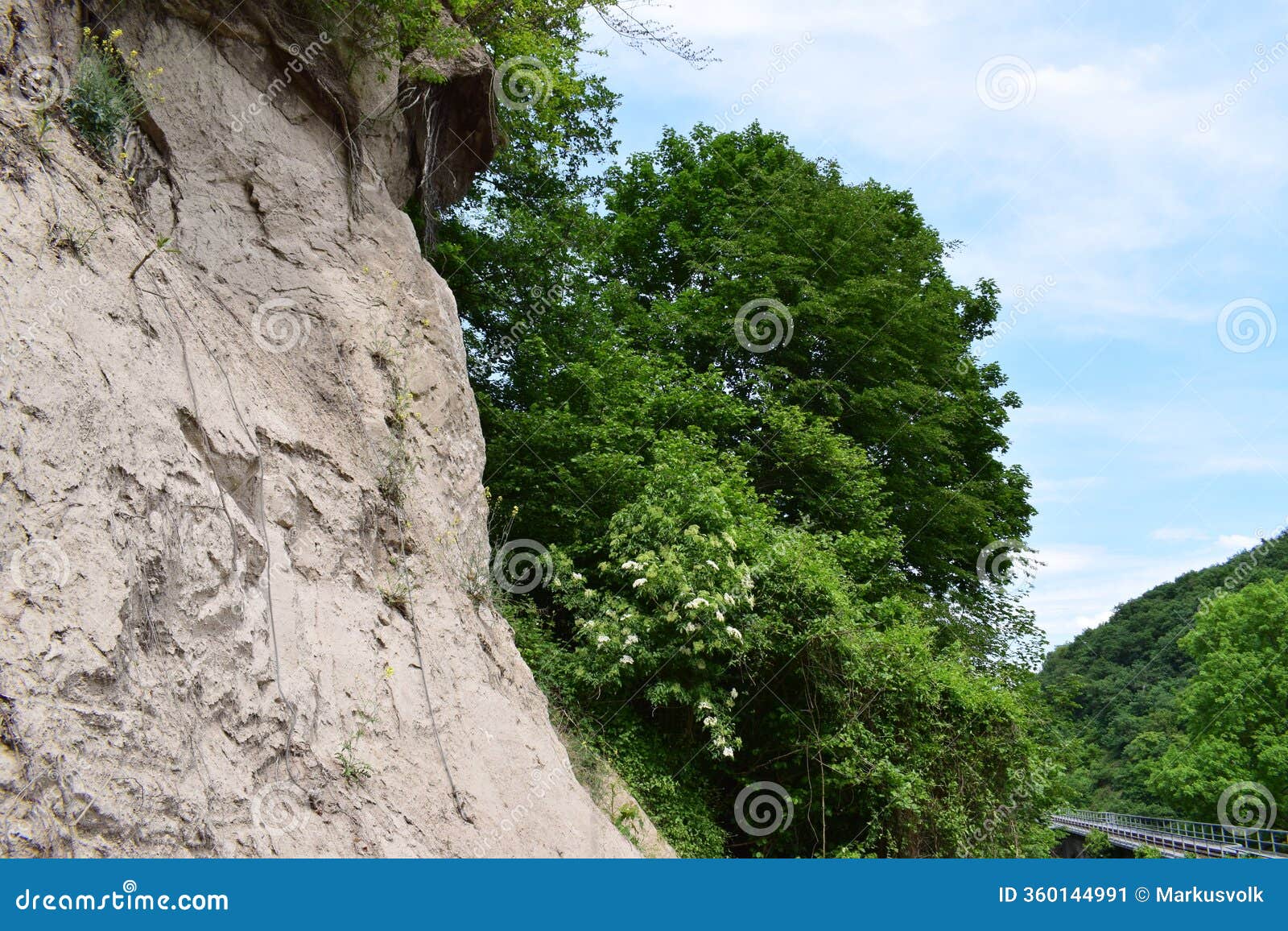 Crumbling Volcano Stone Cliff at a Railroad Bridge Stock Image - Image ...