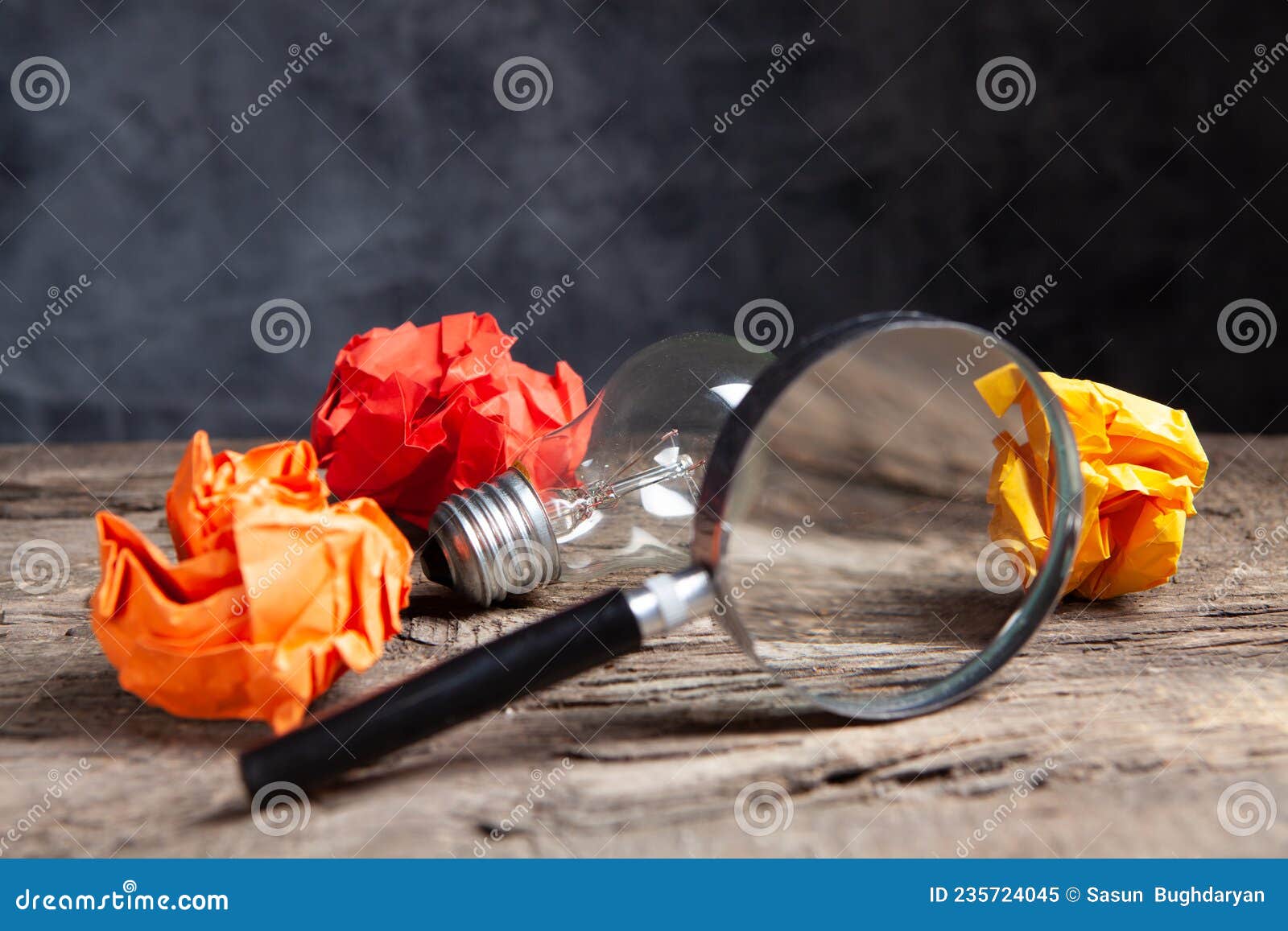 Crumpled Papers, Magnifier and Light Bulb on the Table Stock Image ...