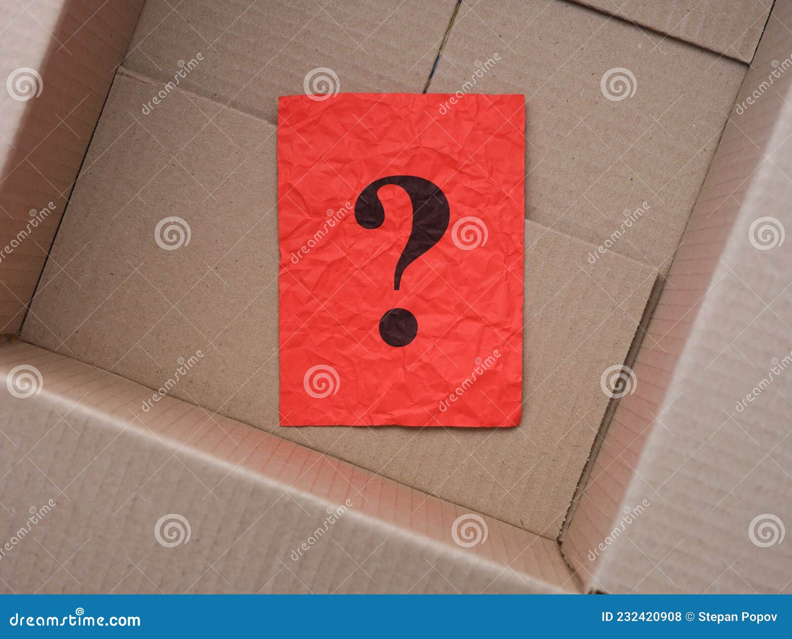 A Crumpled Red Piece of Paper with a Question Mark on it in a Cardboard ...