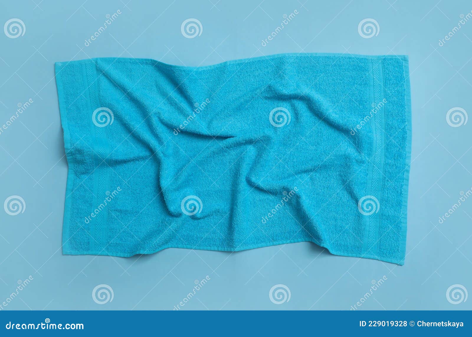 Crumpled Soft Beach Towel on Light Blue Background, Top View Stock ...