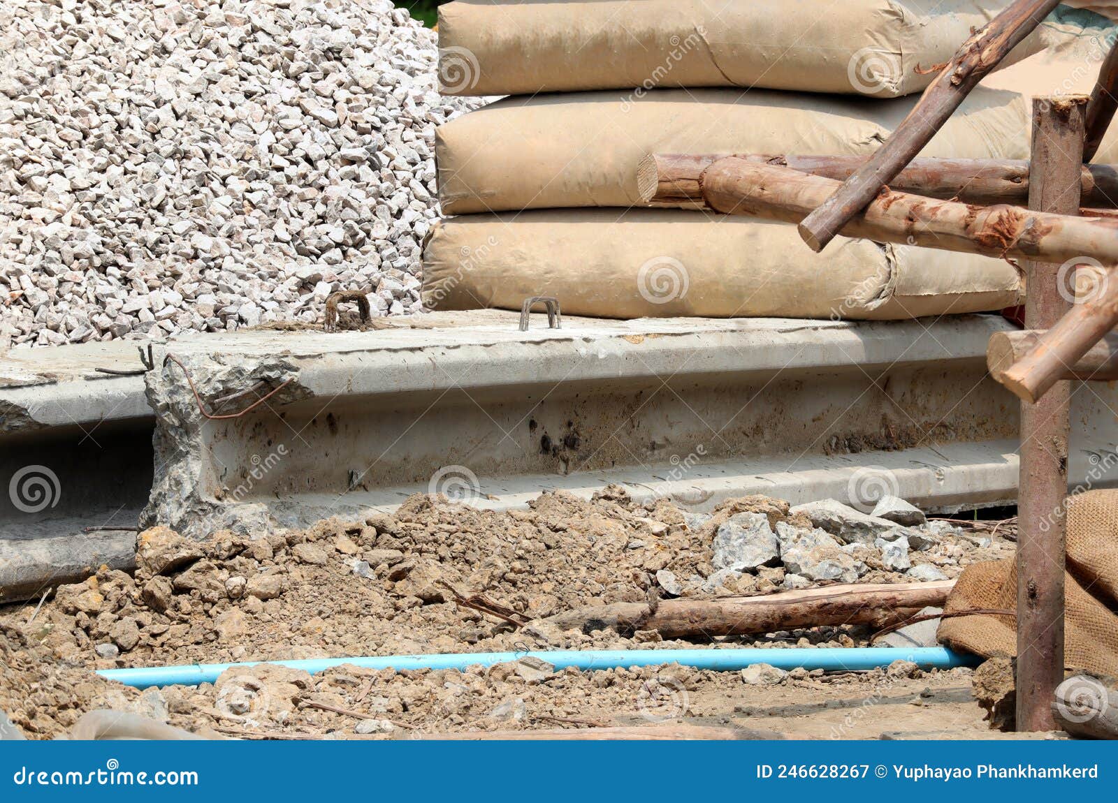 Crushed Rock for Construction and Row of Raw Cement Bag Stack in ...