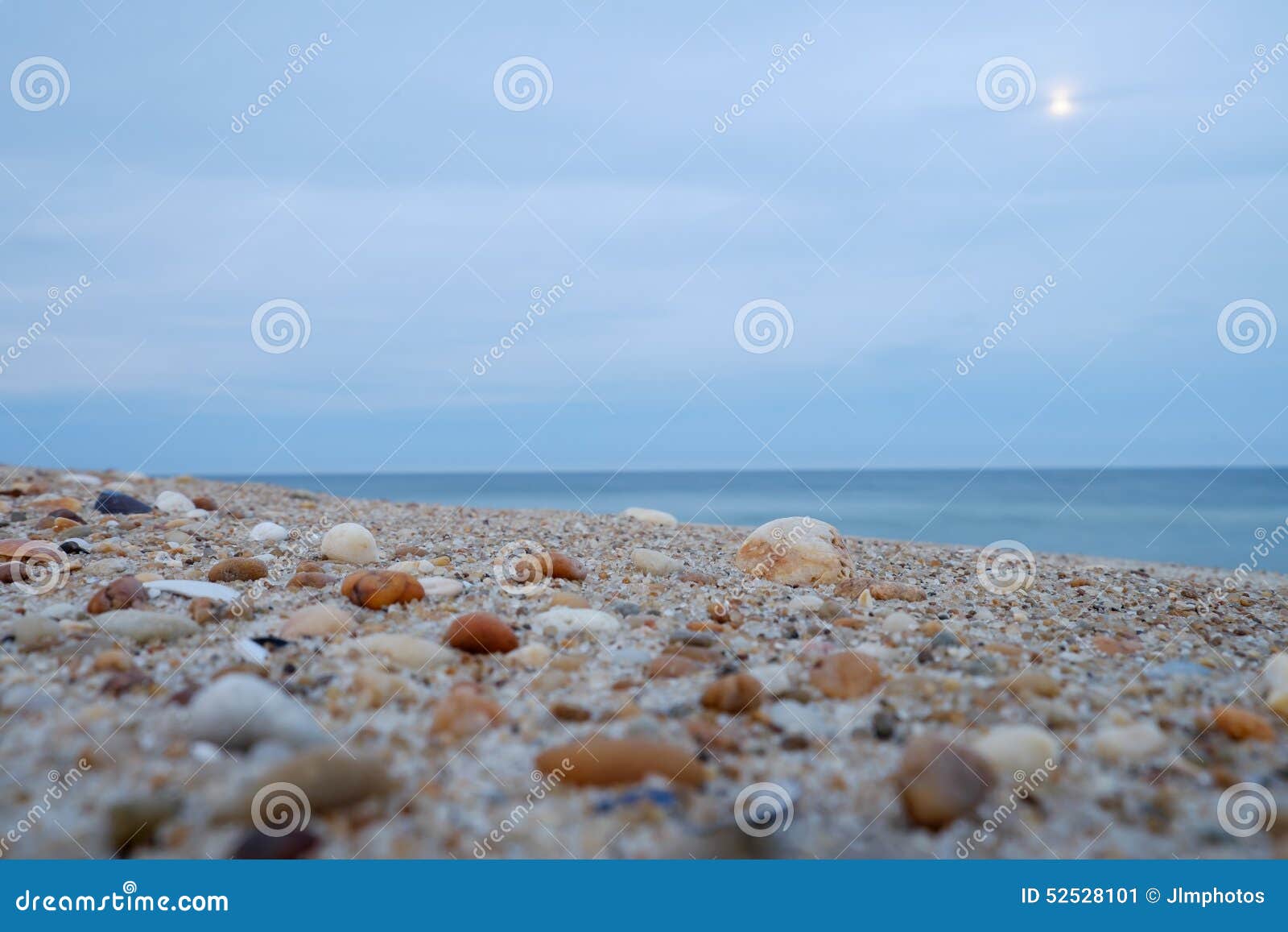 Crushed Shells and Stones during a Moonrise on a Beach at Dusk Stock ...
