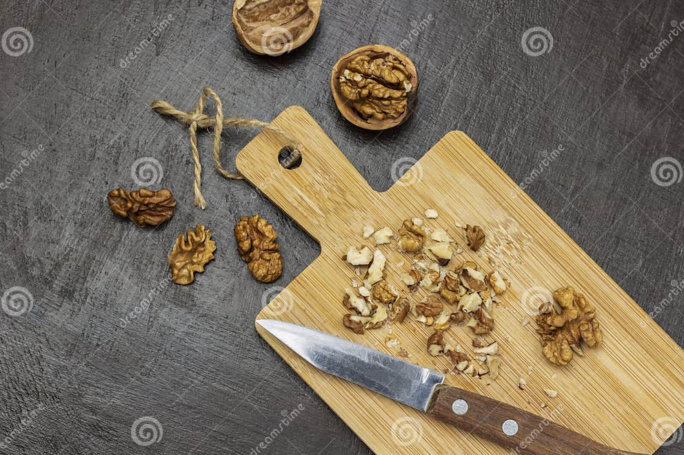 Crushed Walnuts and Knife on Cutting Board. Walnut Shell and Walnut ...