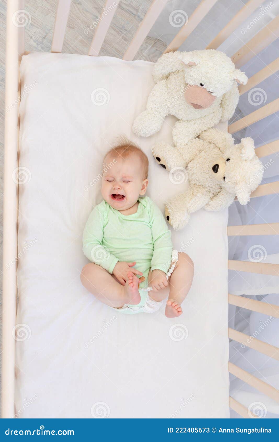 A Crying Baby in a Crib with a Teether in the Bedroom Stock Image ...