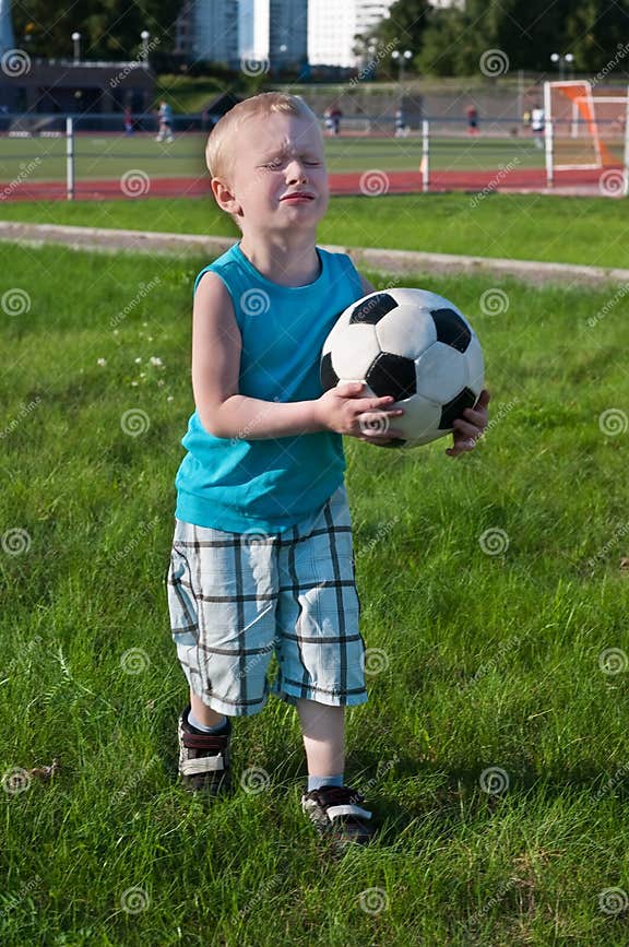 Crying boy with a ball stock photo. Image of competition - 10886760