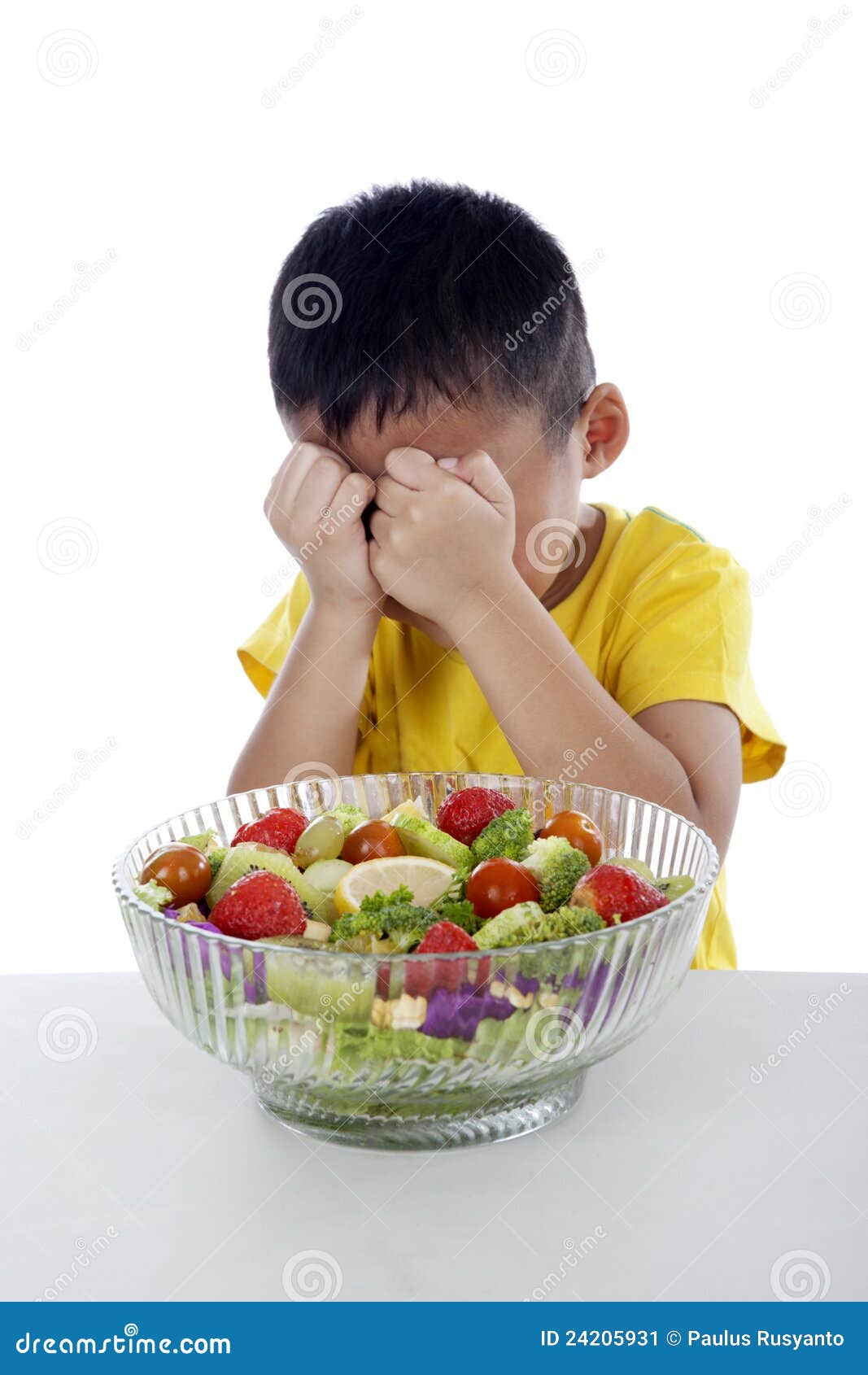 Crying Boy With A Bow Of Fruit Salad Stock Image - Image: 24205931