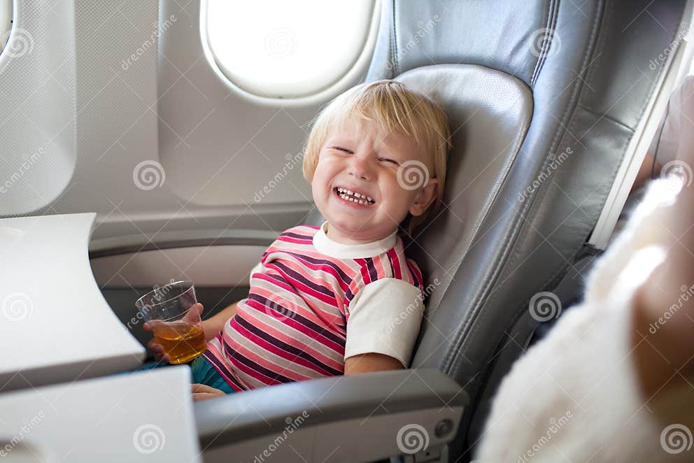 Crying child in airplane stock image. Image of arrivals - 24056401