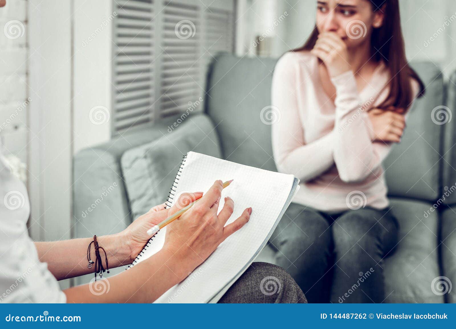 Therapist Making Notes while Listening To Crying Stressed Client Stock ...