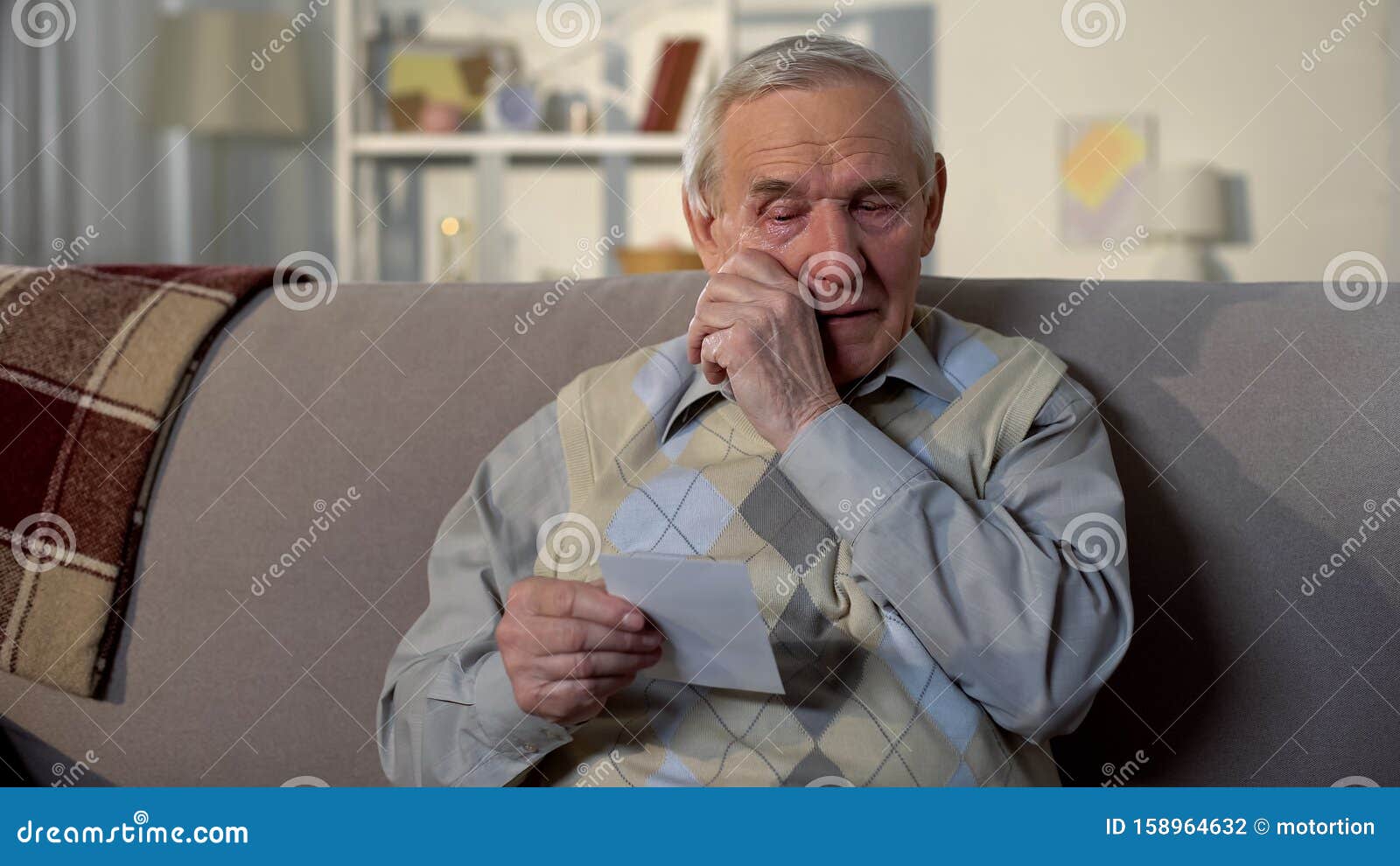 Crying Elderly Man Looking At Photo Remembering Old Lost Friend