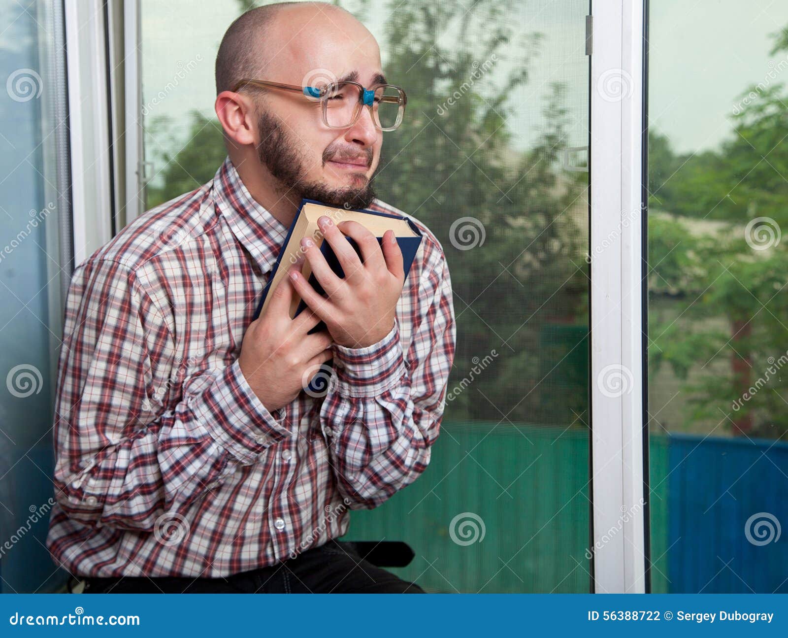 Crying nerd reading a book stock photo. Image of face - 56388722