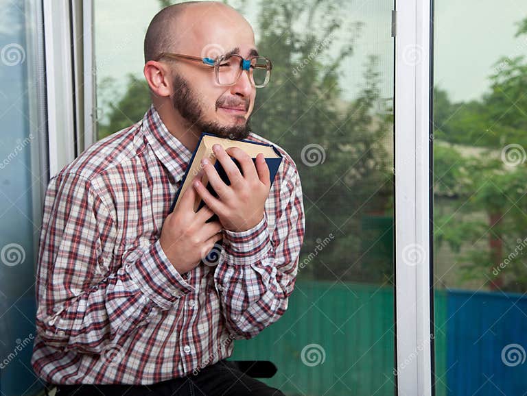 Crying nerd reading a book stock photo. Image of face - 56388722