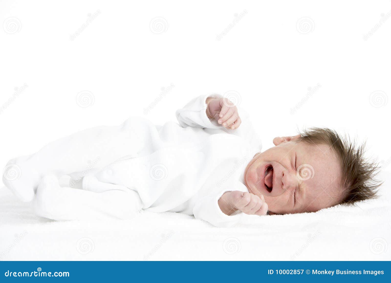 Crying Newborn Baby Lying On A Sofa, Covered By A White Blanket. Side ...