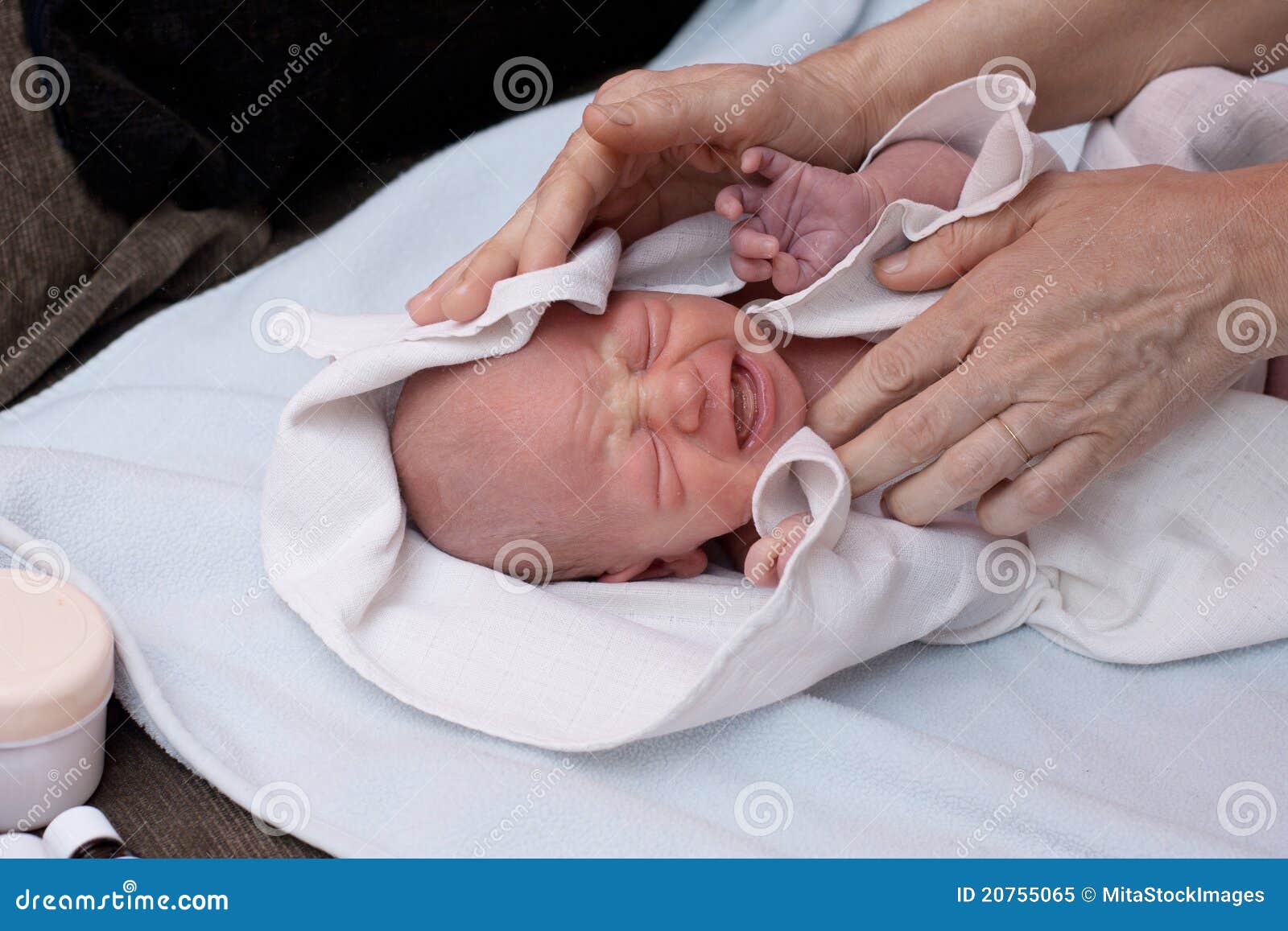Crying Newborn Baby Lying On A Sofa, Covered By A White Blanket. Side ...