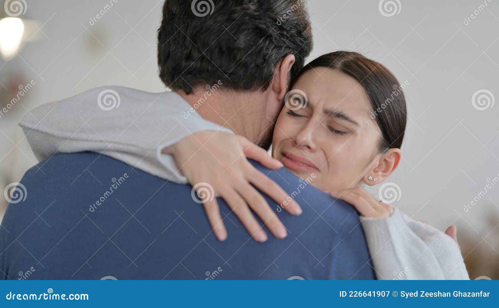 Crying Spanish Woman Hugging Man at Home Stock Image - Image of ...