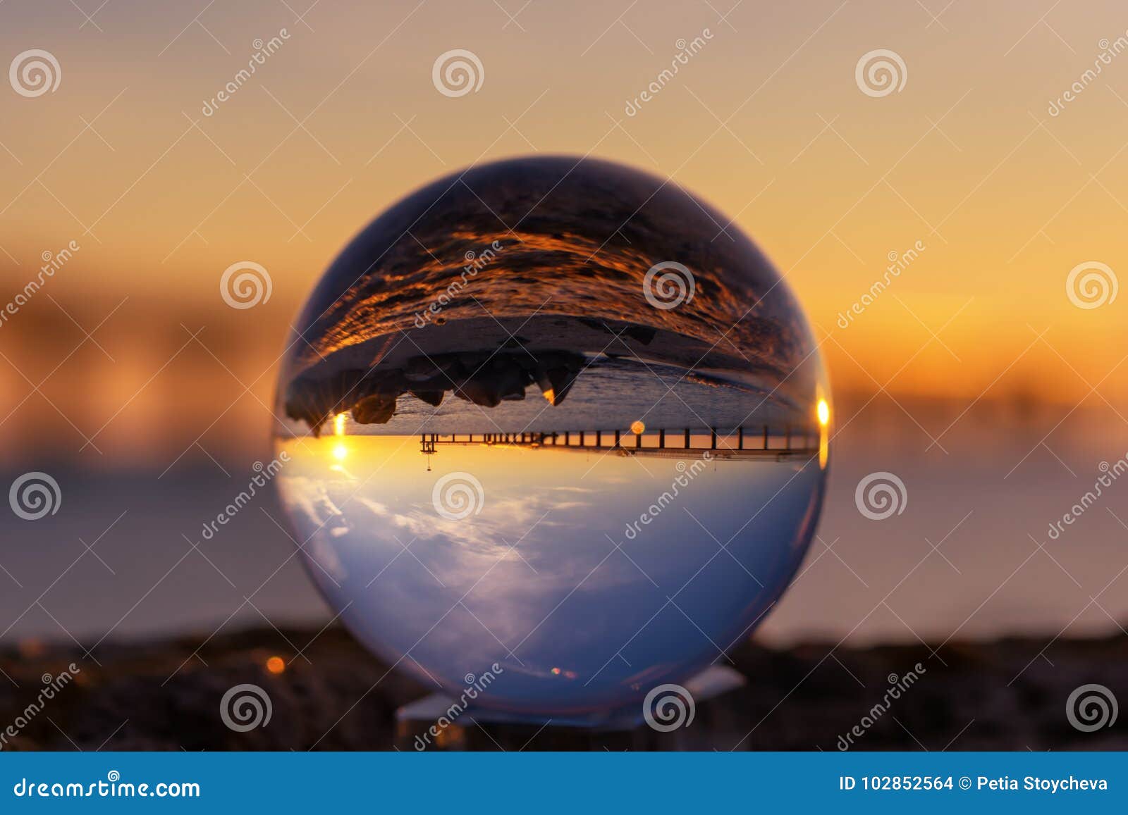 Crystal Ball Reflection on the Seashore in Sunrise Light. Reflection of ...