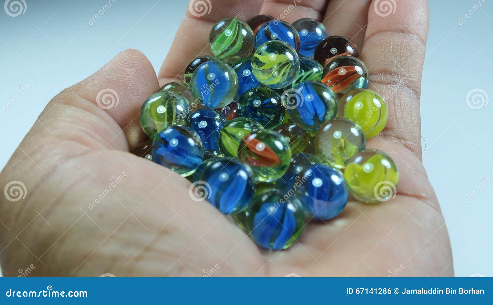 Crystal Marbles on the Hand Stock Photo - Image of hand, yellow: 67141286