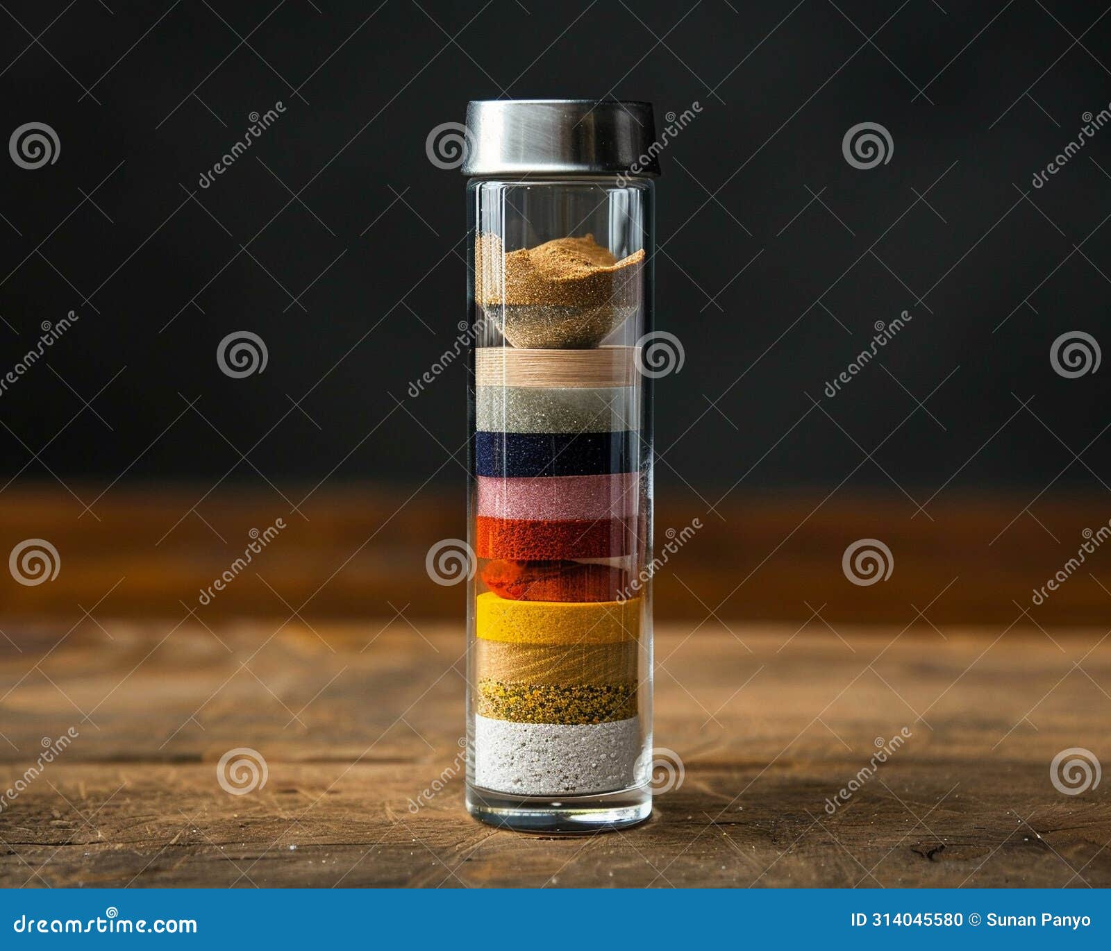 A Crystal Vial Filled with Different Layers of Colored Sand, Each Layer ...