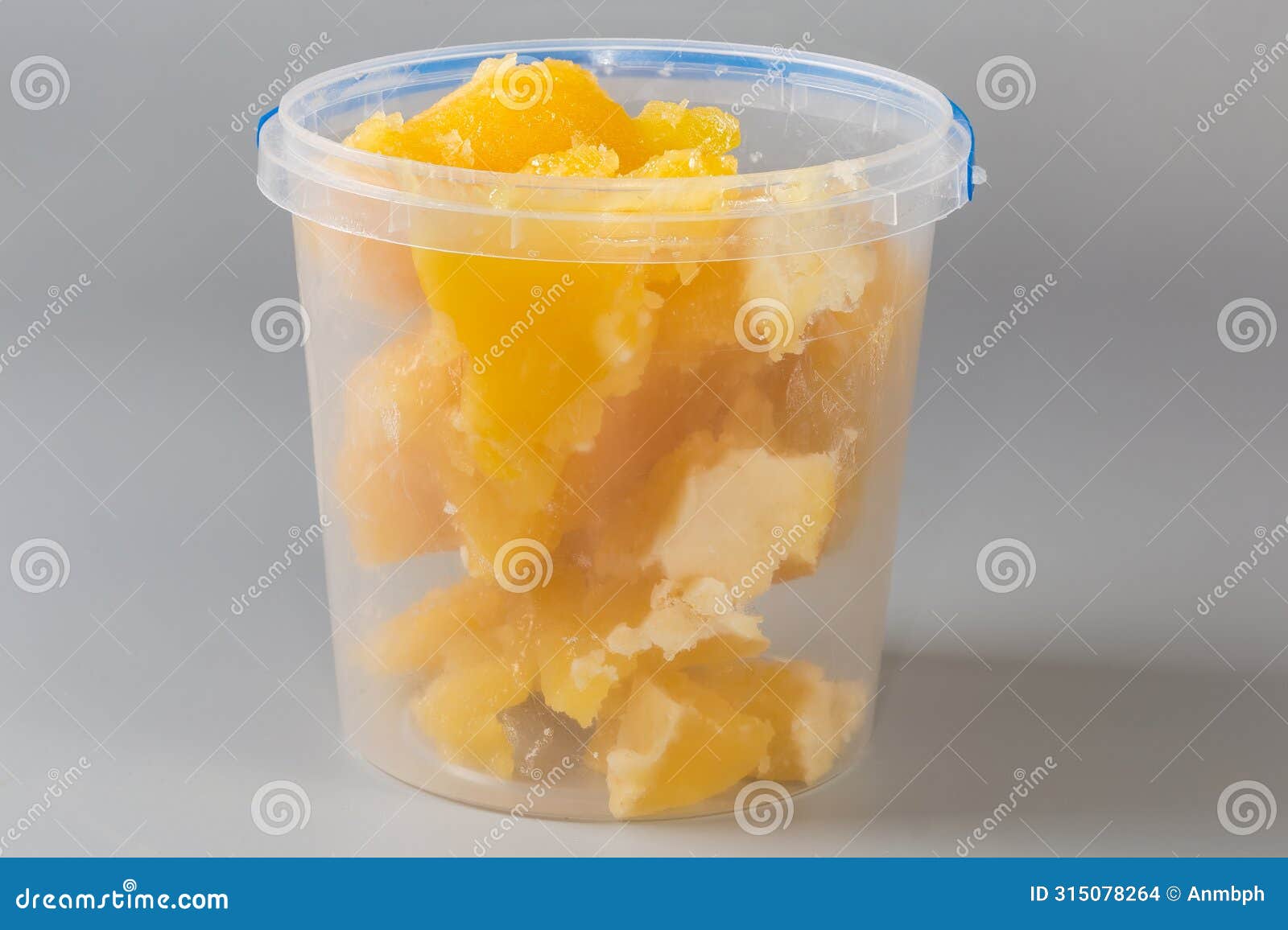 Crystallized Honey in Open Plastic Container on a Gray Background Stock ...
