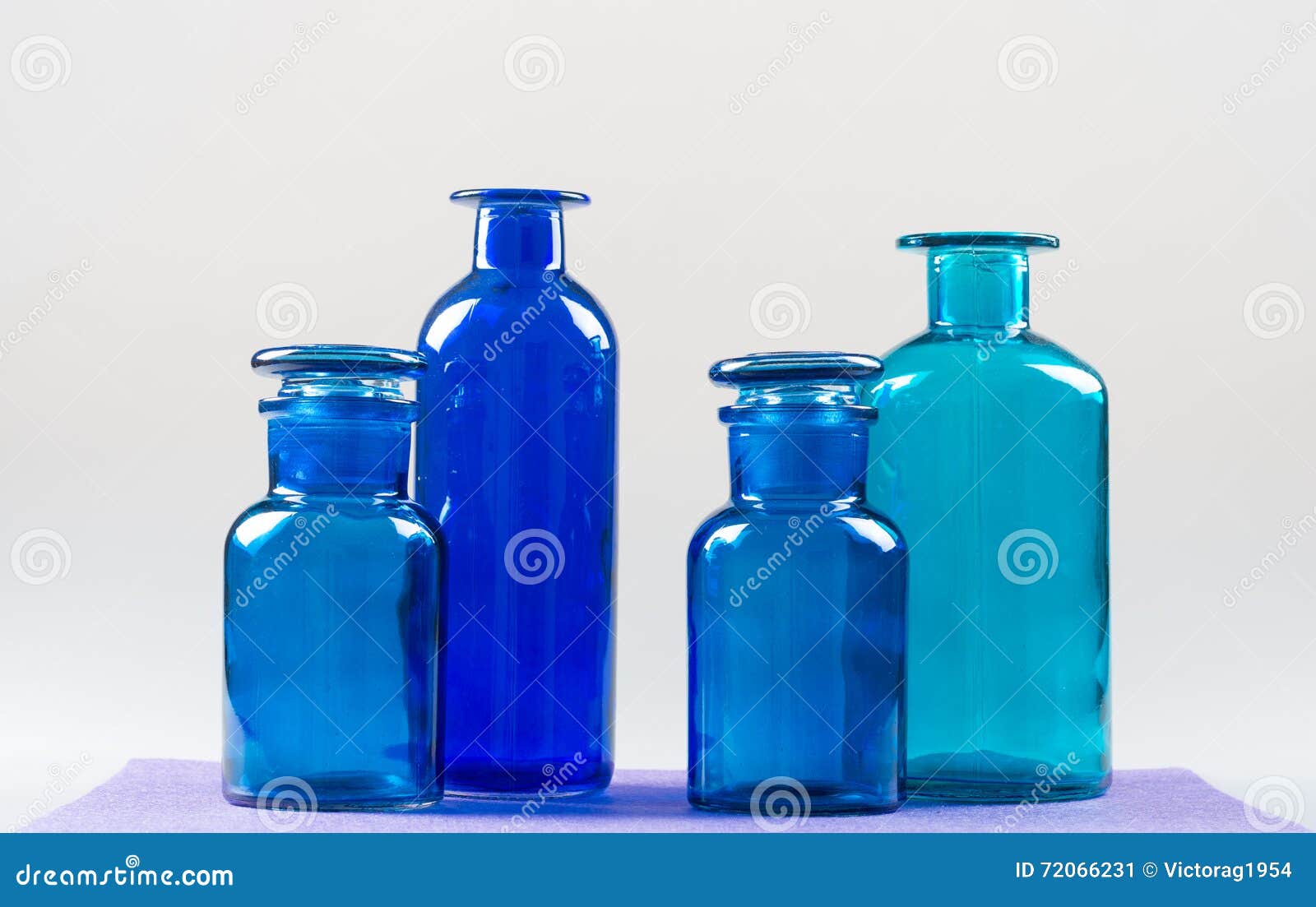 Cuatro Botellas Azules Y Su Transparencia De Cristal Imagen de archivo ...