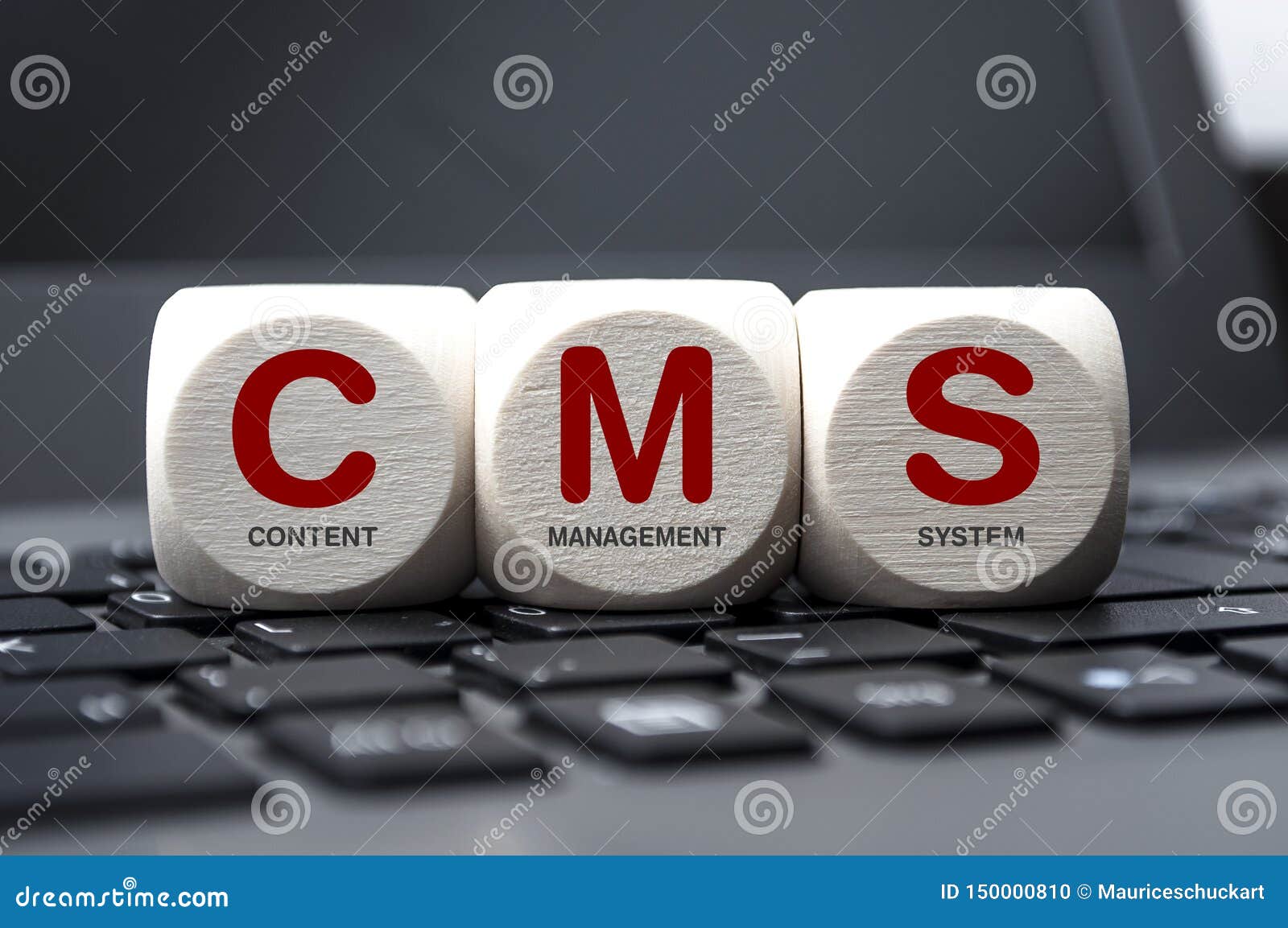 Cubes and Dice on Laptop Keyboard with CMS Content Management System ...