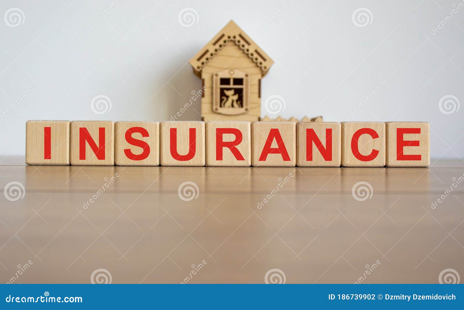 Cubes Form the Word Insurance in Front of a Miniature House Stock Photo ...