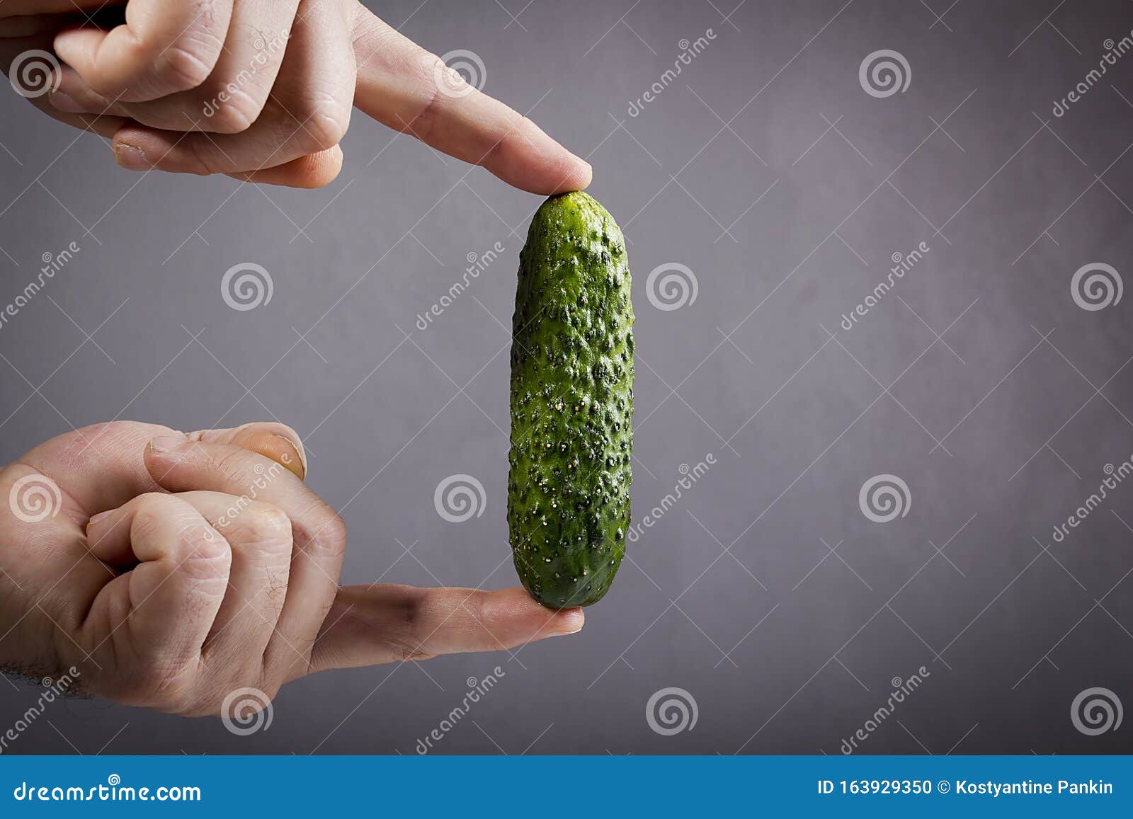 Cucumber in hand stock photo. Image of vegan, fresh - 163929350