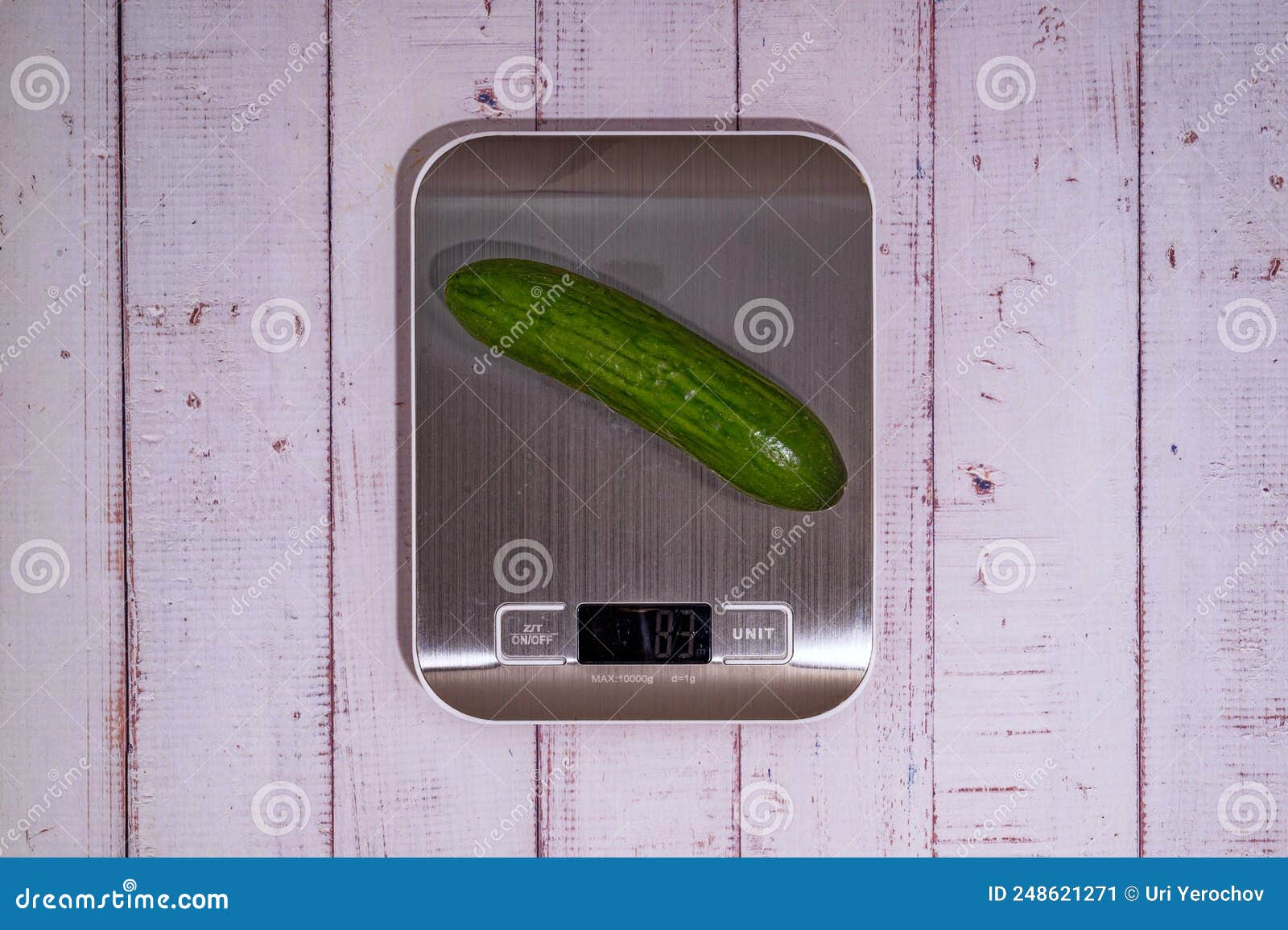 An Cucumber Lies on a Digital Kitchen Scale on a Table of Light Boards ...