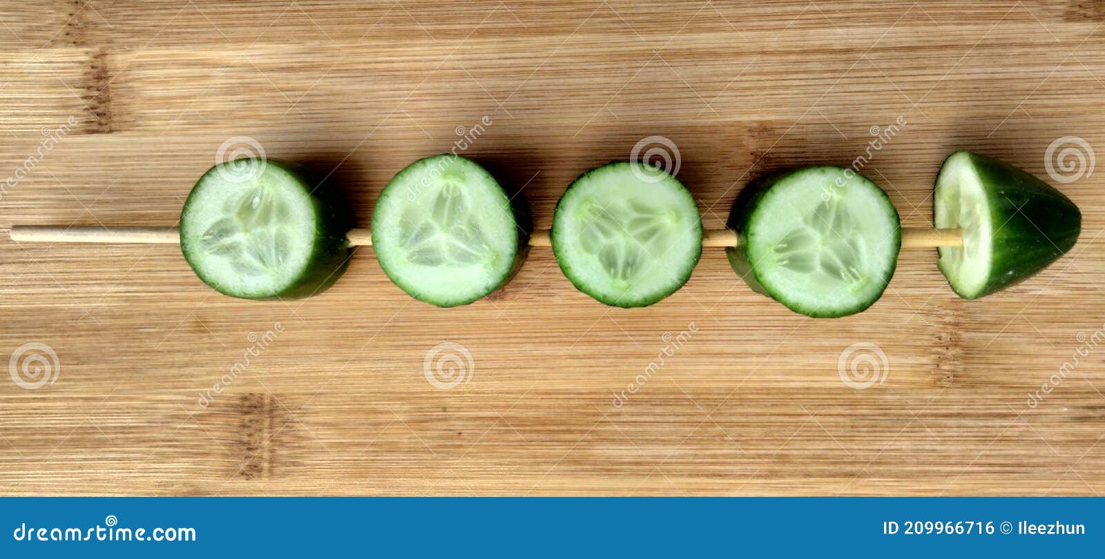 Cucumber Slices in Stick on Wooden Background Stock Photo - Image of ...