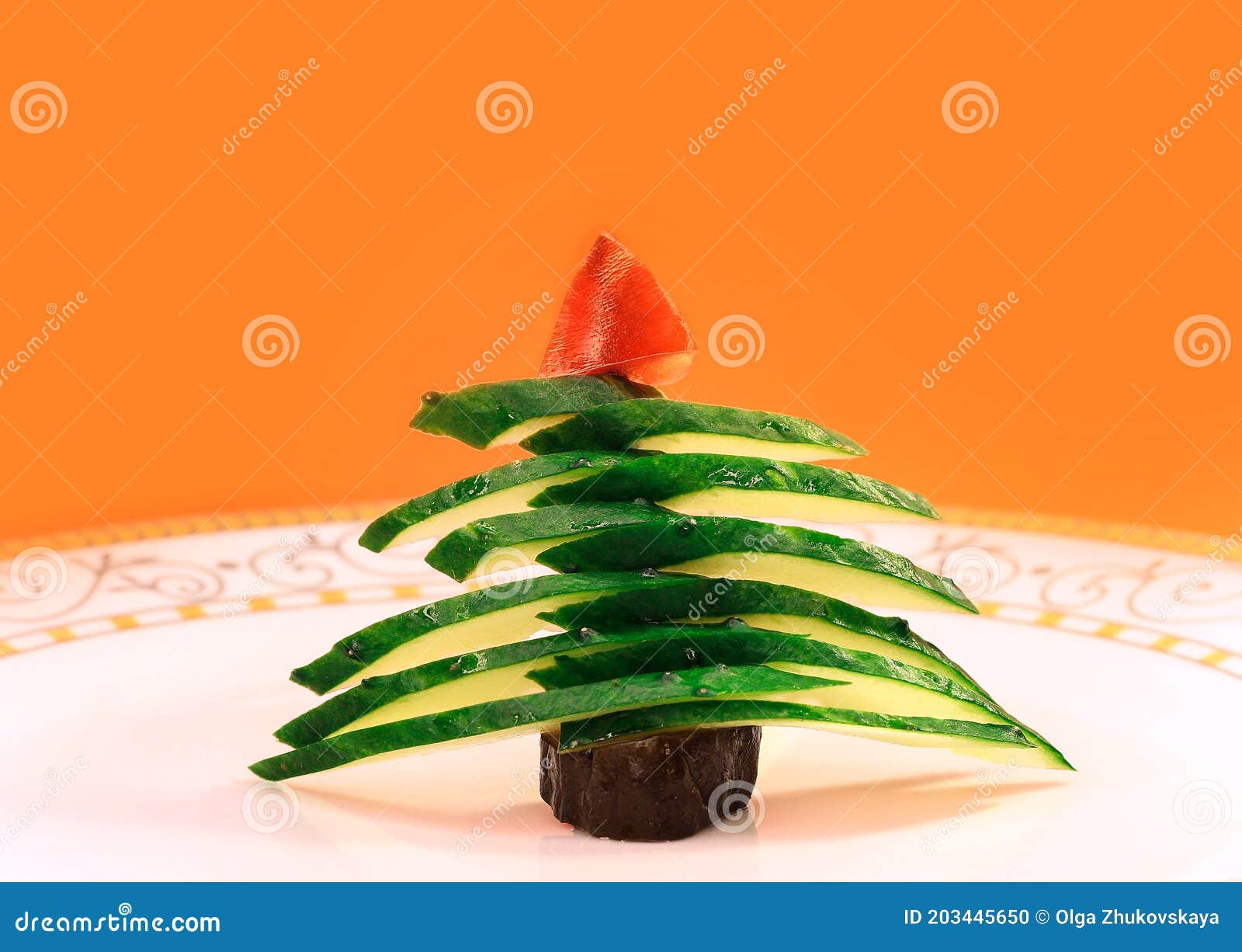 Cucumber Tree on a White Plate and Orange Background Stock Photo ...