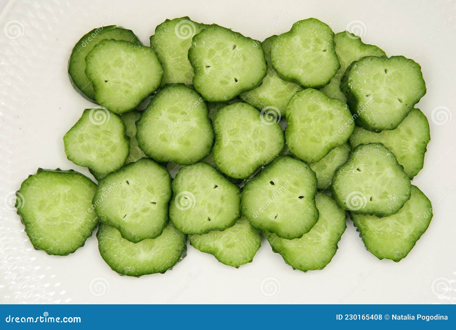 Cucumbers on Plates Pieces on a White Background Stock Photo - Image of ...