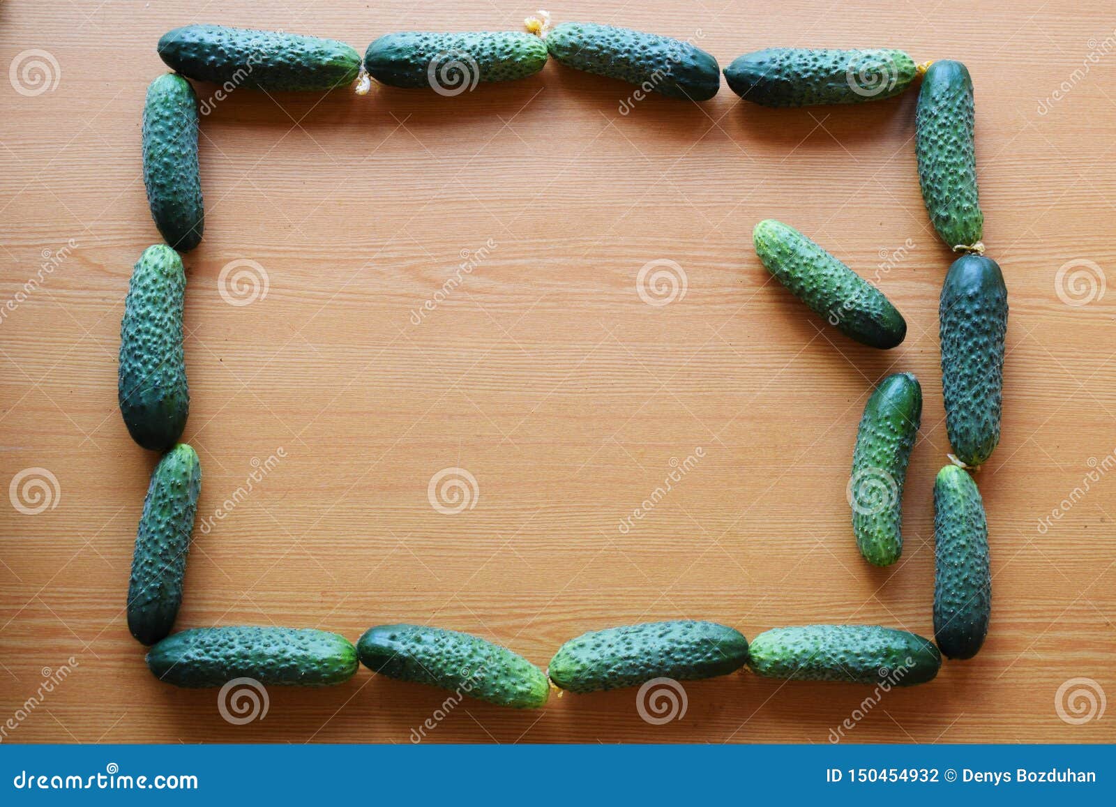 Cucumbers on a Table, Forming a Frame for Copy Space. Stock Photo ...