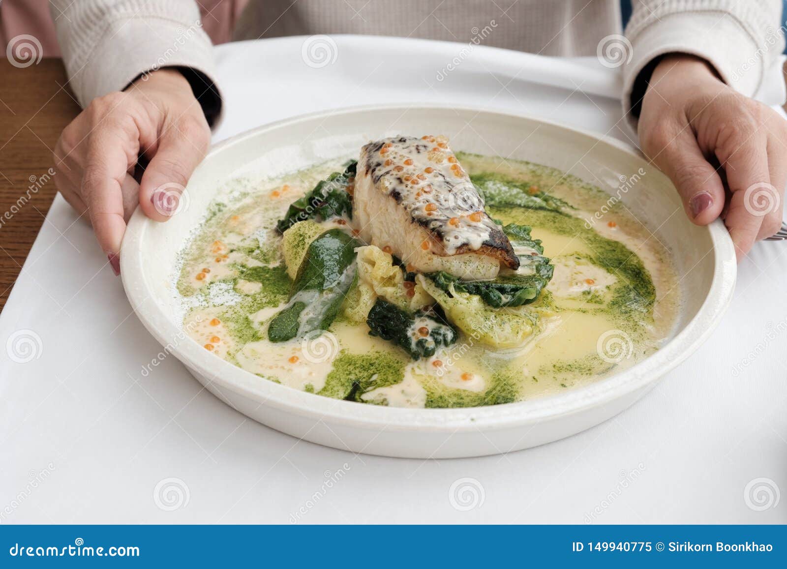 Cuisine of Halibut Fish in a White Plate with Hands in Frame Stock ...