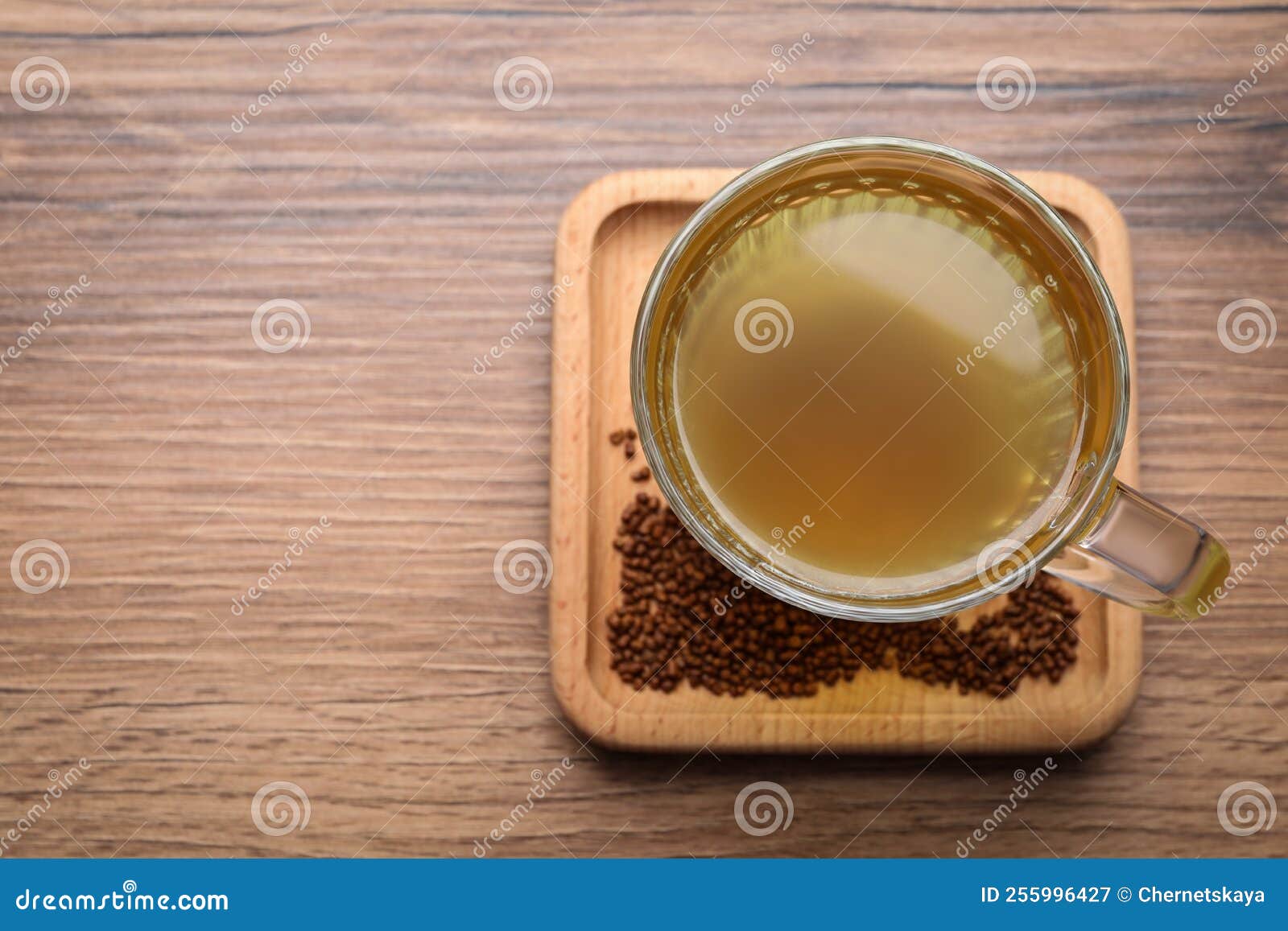 Cup of Aromatic Buckwheat Tea and Granules on Wooden Table, Top View ...
